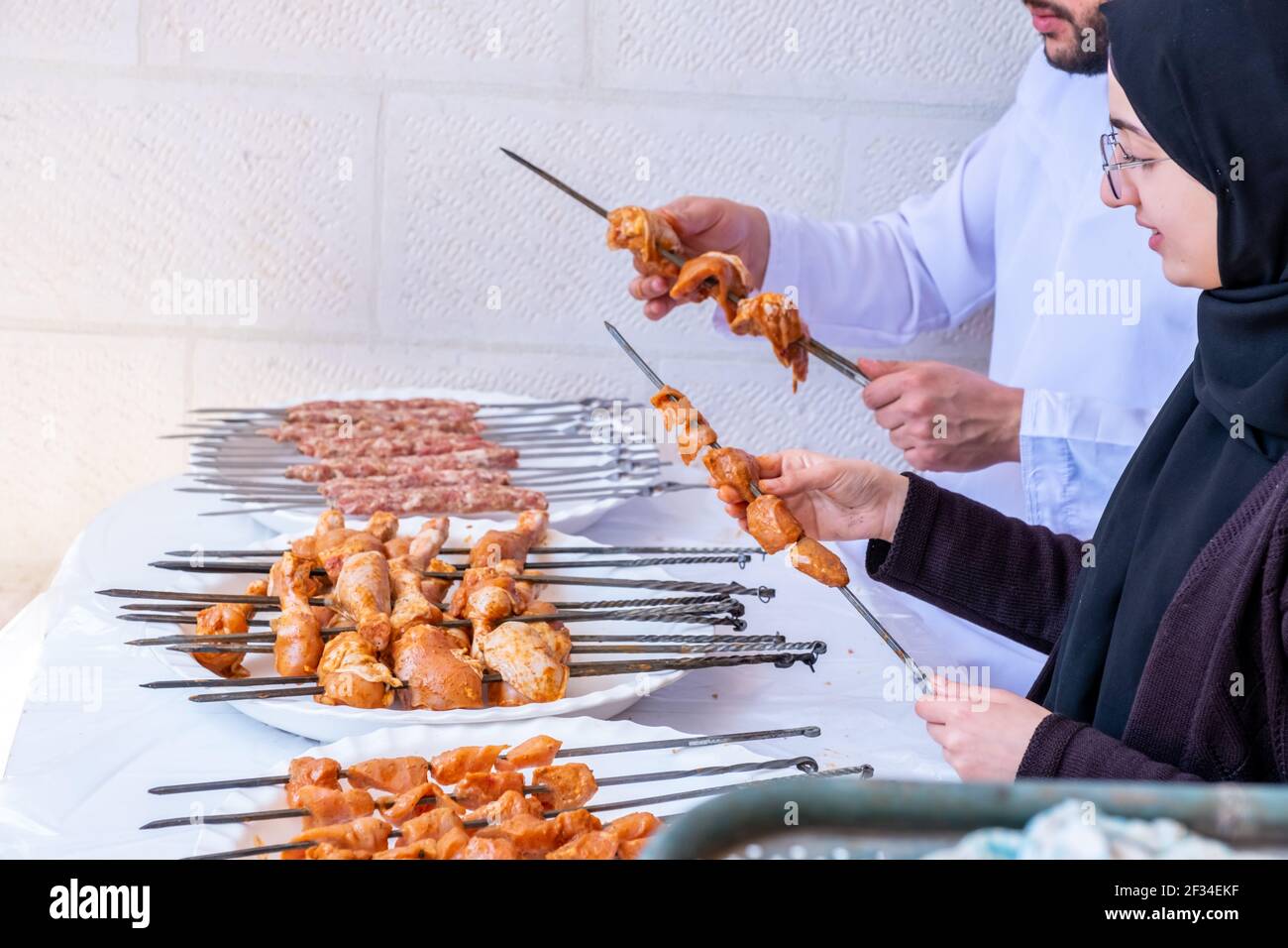 Arabic Muslim family preparing for barbeque Stock Photo - Alamy