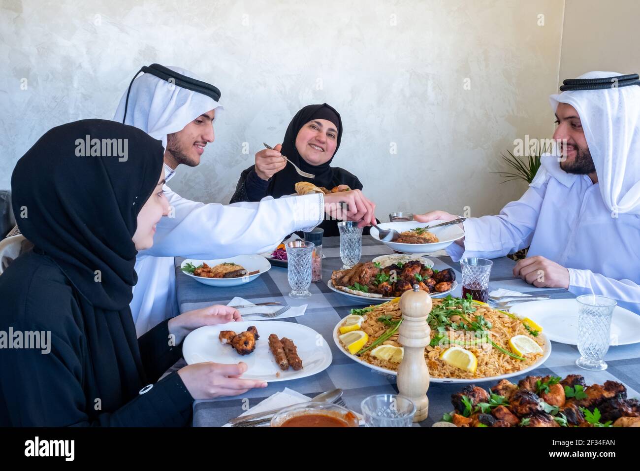 Happy Arabic Muslim family enjoying the food together in Ramadan Stock ...