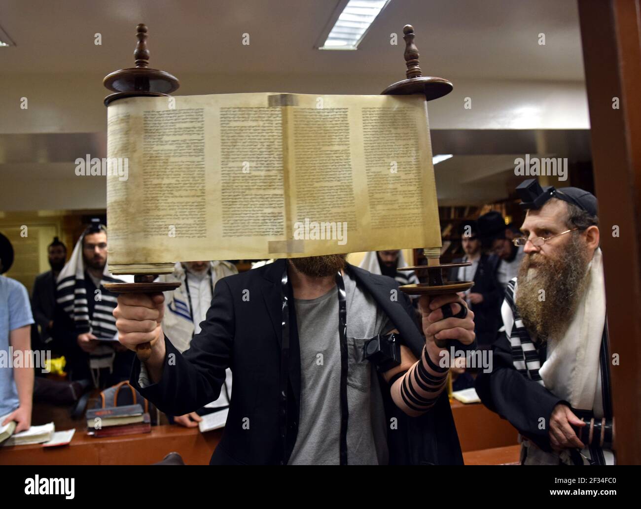 After a reading, a Torah is lifted and shown to the congregation. At a ...