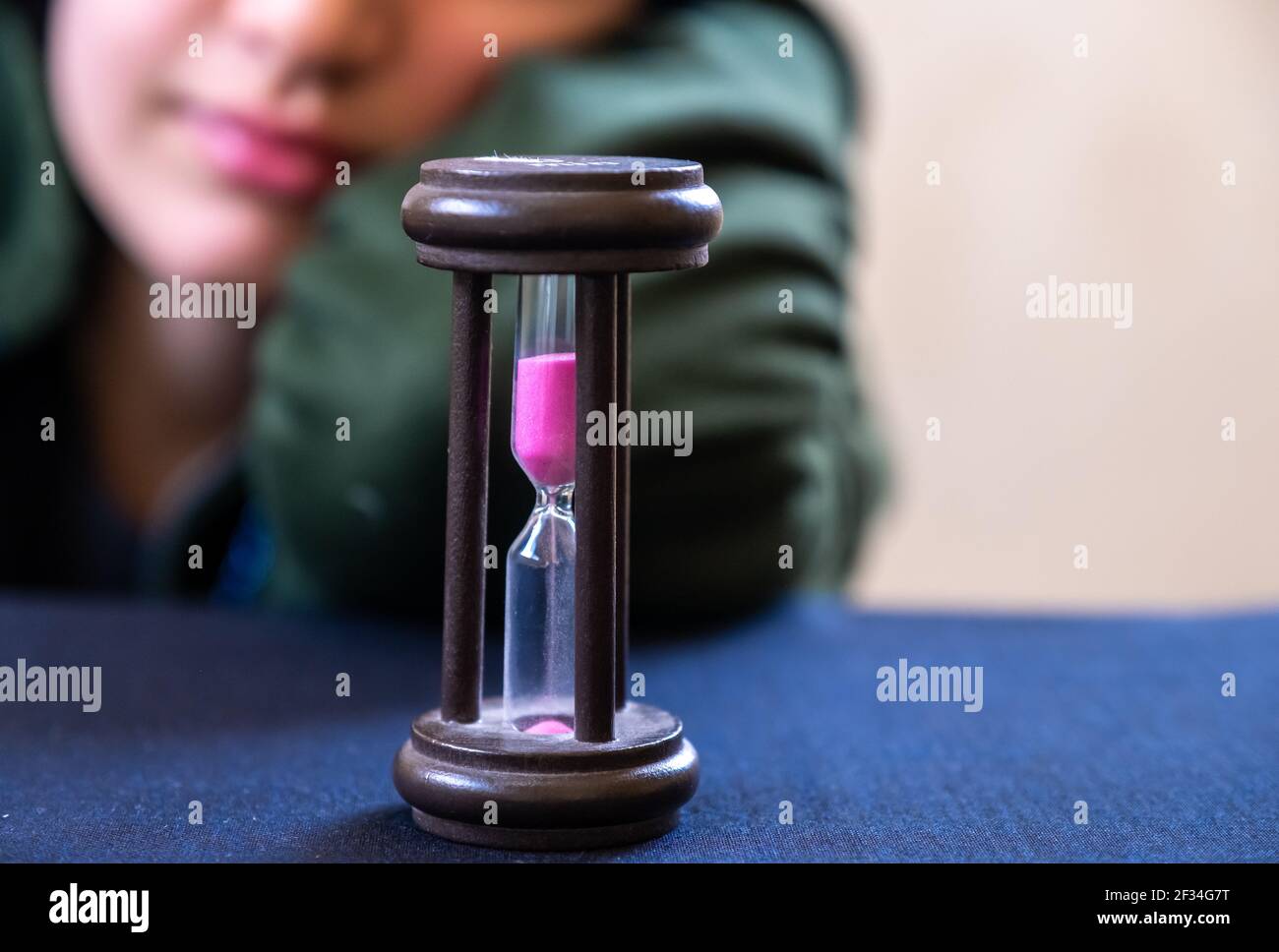 Arabic Muslim watching sand watch to check time Stock Photo - Alamy