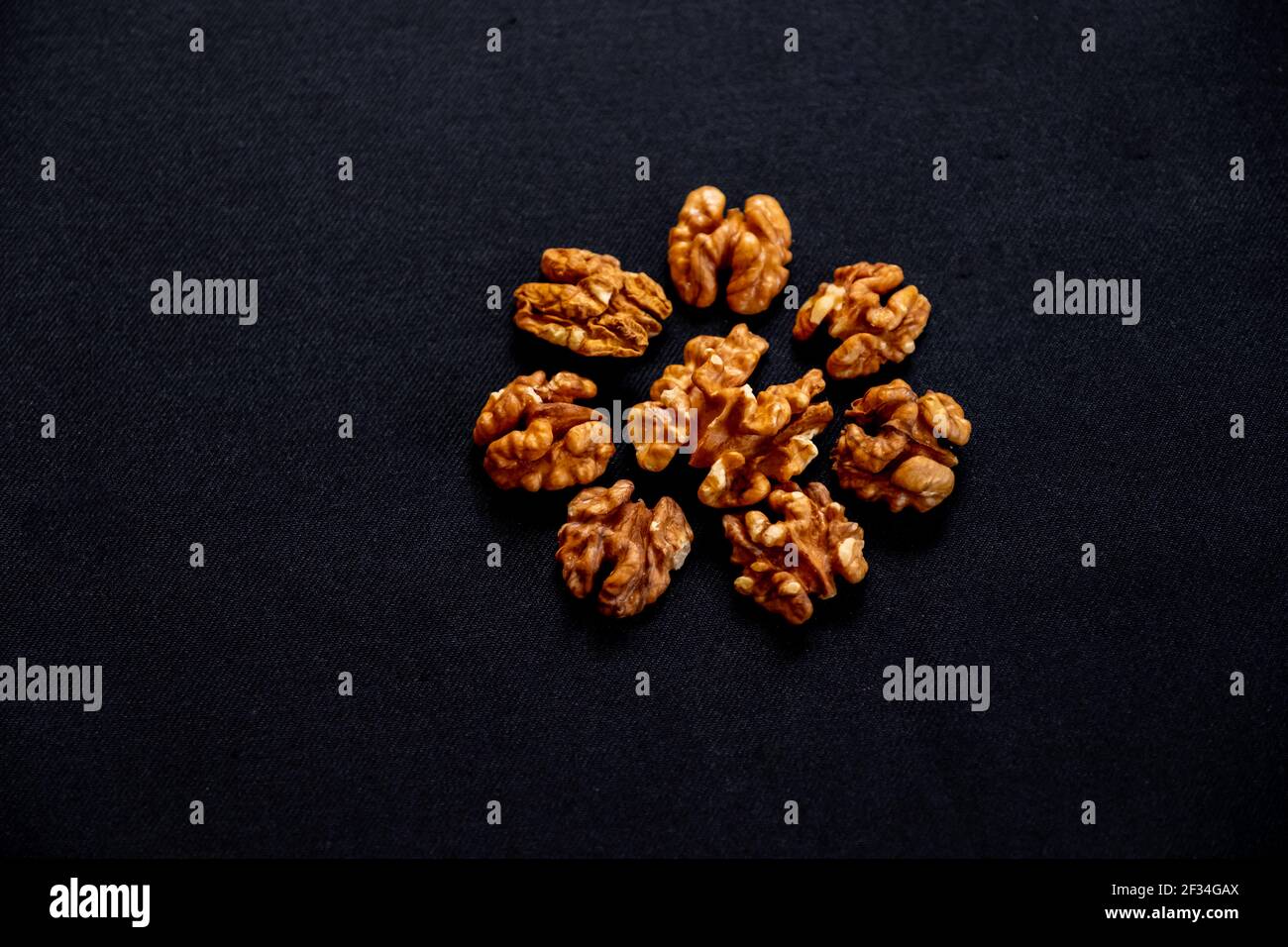 Bunch of walnut together on black background Stock Photo - Alamy