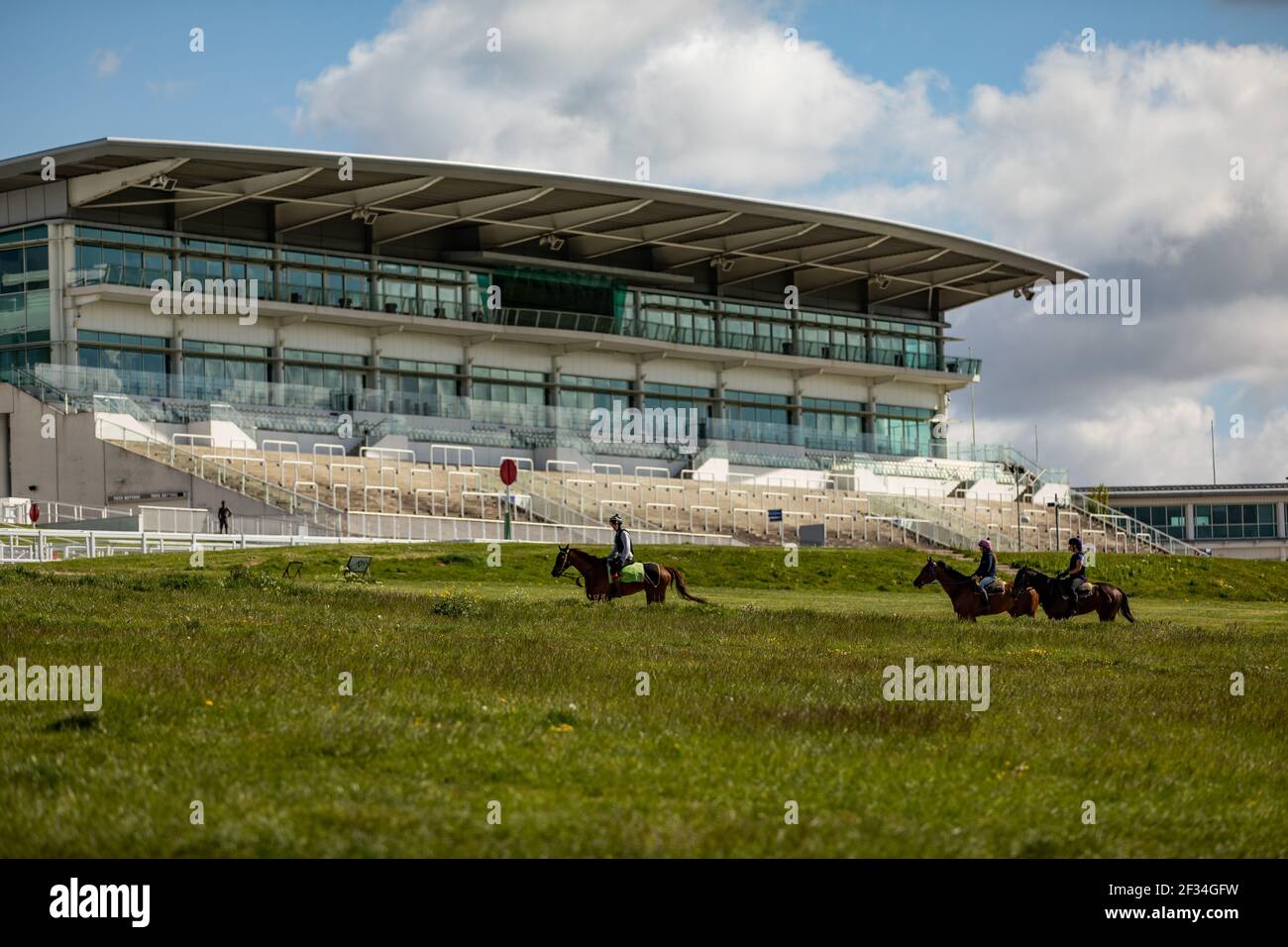 Riders talking out horses onto the gallops at Epsom Racecourse, that ...