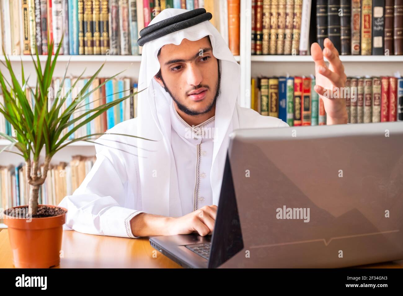 Arab man using laptop typing hi-res stock photography and images - Alamy