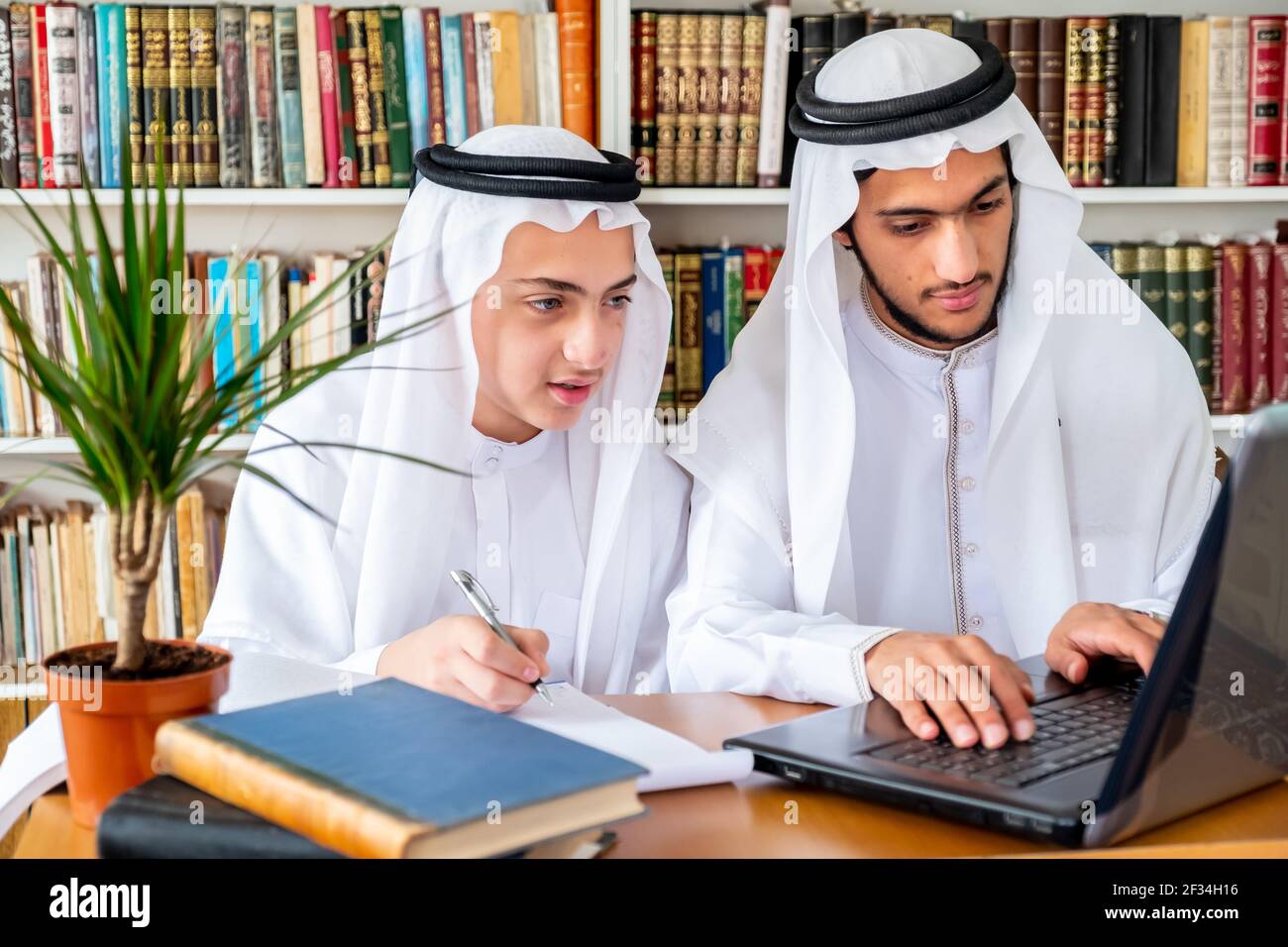 Two Arabic businessmen discussing business together Stock Photo - Alamy