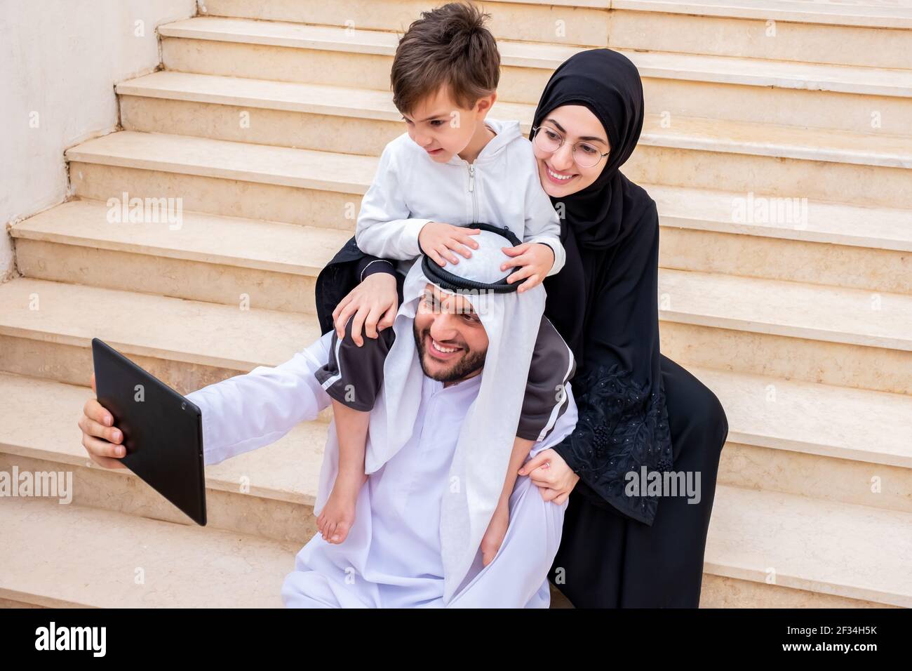 Happy Arabic Muslim family using video to call their family Stock Photo ...