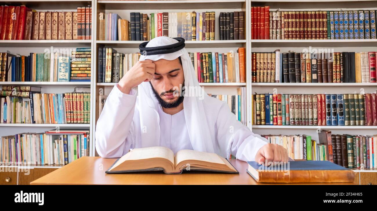 Arabic Muslim man reading old books Stock Photo - Alamy