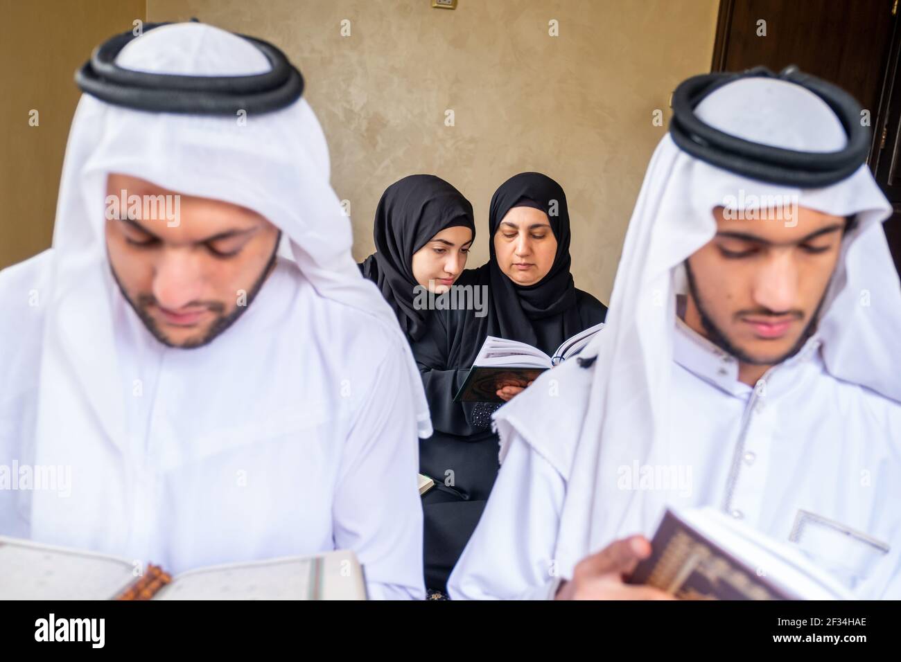Happy msulim family reading Quran togther Stock Photo - Alamy