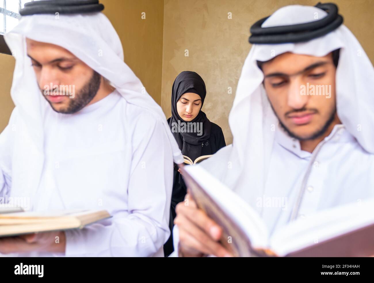 Happy msulim family reading Quran togther Stock Photo - Alamy