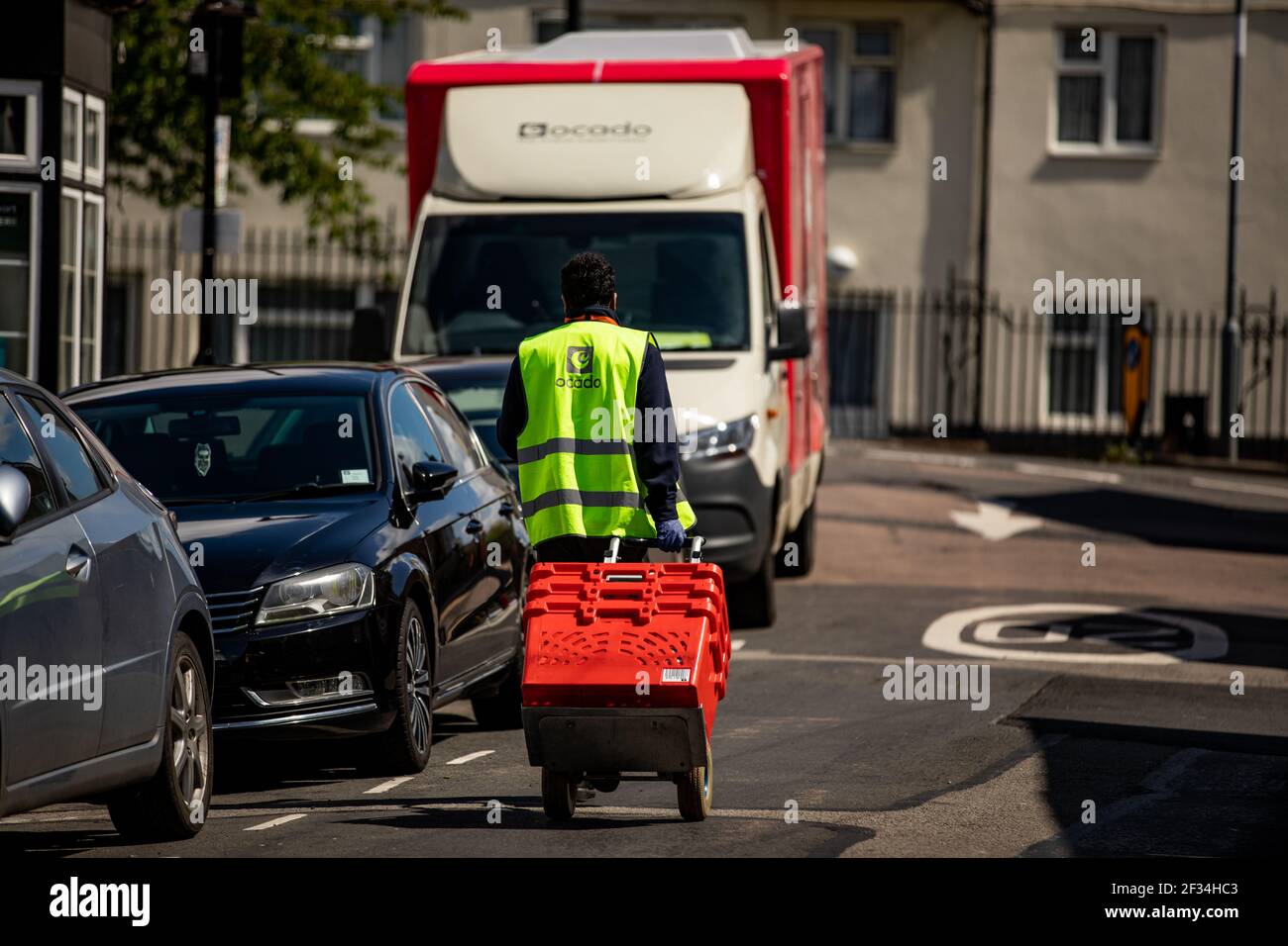 A Ocado delivery driver after dropping off food shopping outside a ...