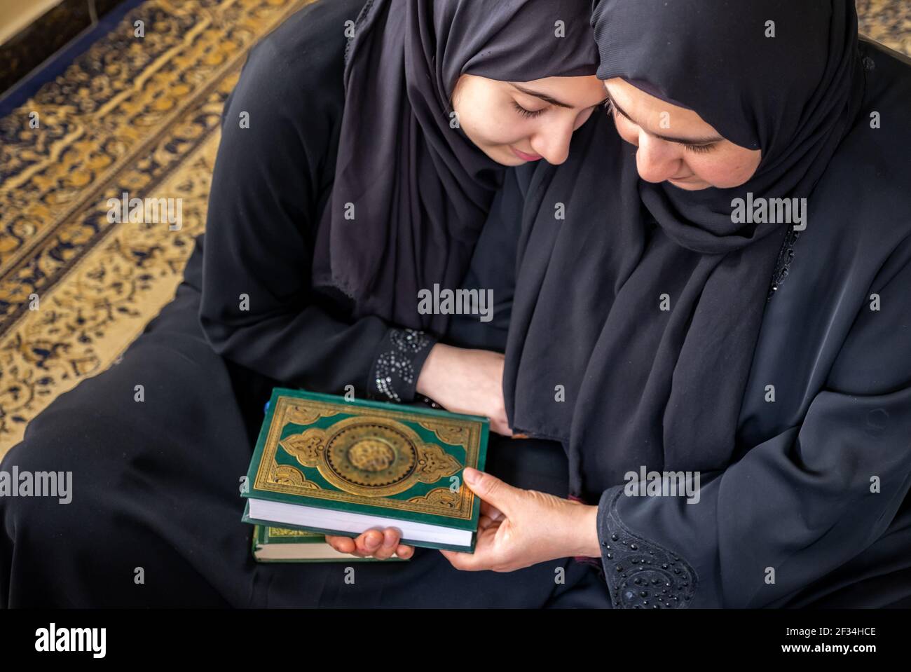Arabic muslim mother and her daughter hugging each other Stock Photo ...