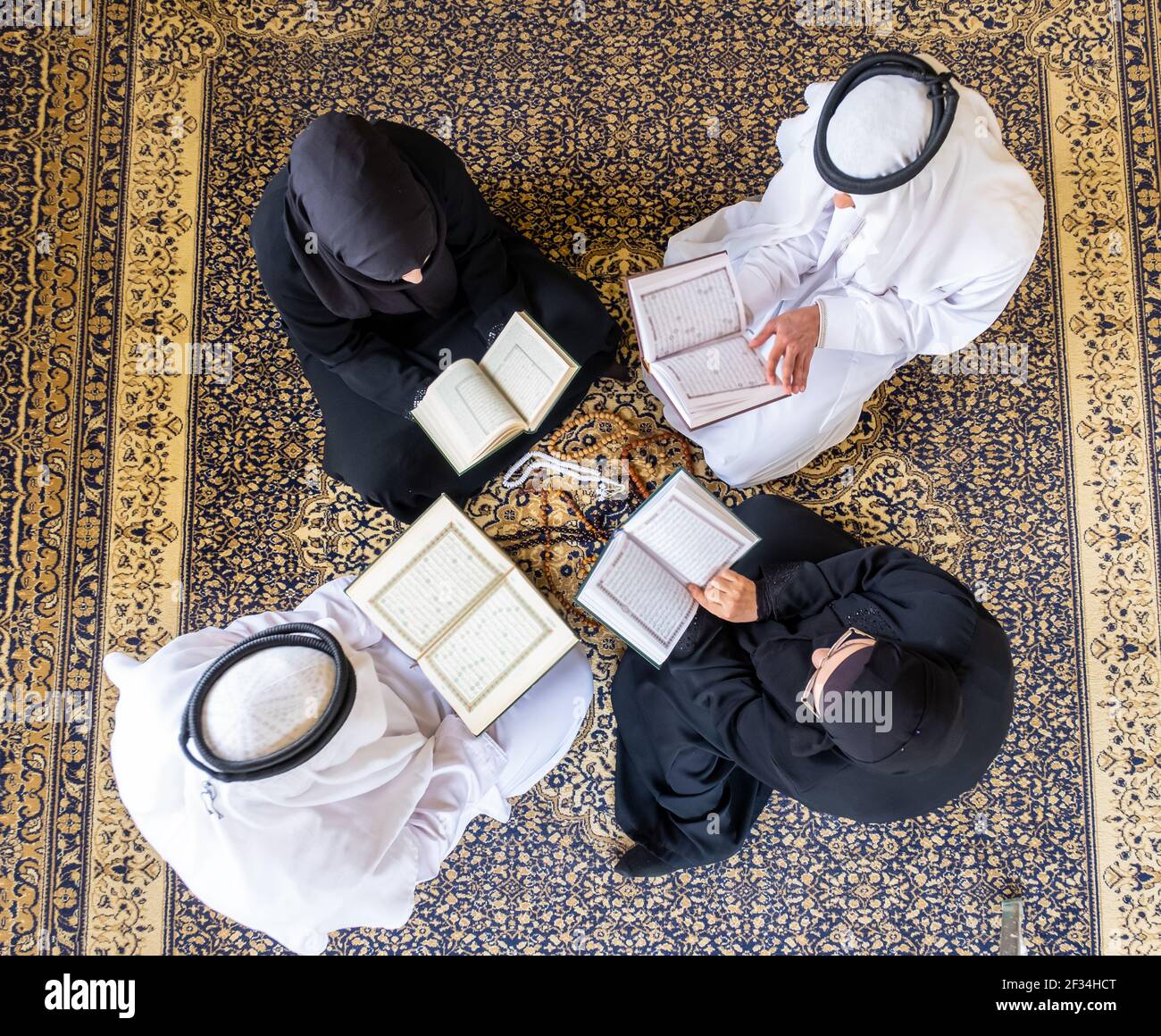 Top view of muslim family members reading quraan together Stock Photo ...