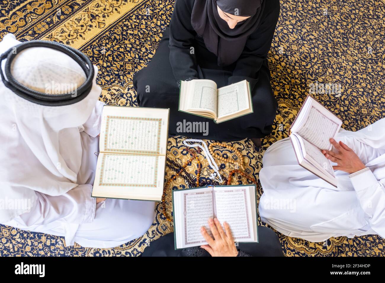 Top view of muslim family members reading quraan together Stock Photo ...