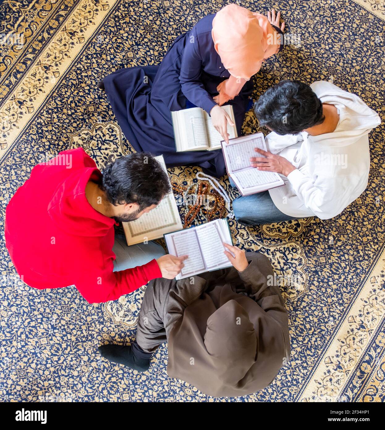 Top view of muslim family members reading quraan together Stock Photo ...