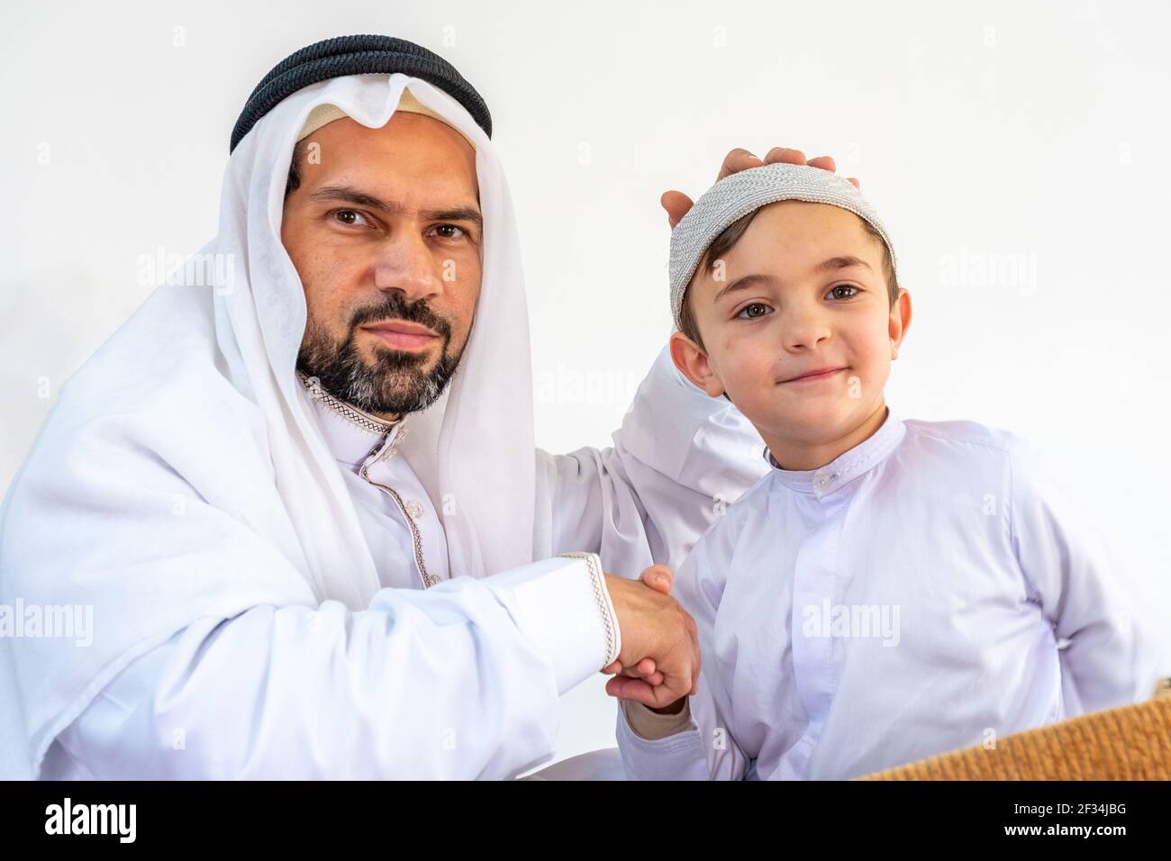 Arabic Muslim father and son feeling happy together Stock Photo - Alamy