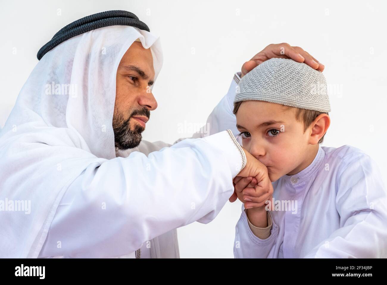 Arabic muslim son kissing his father hand Stock Photo - Alamy