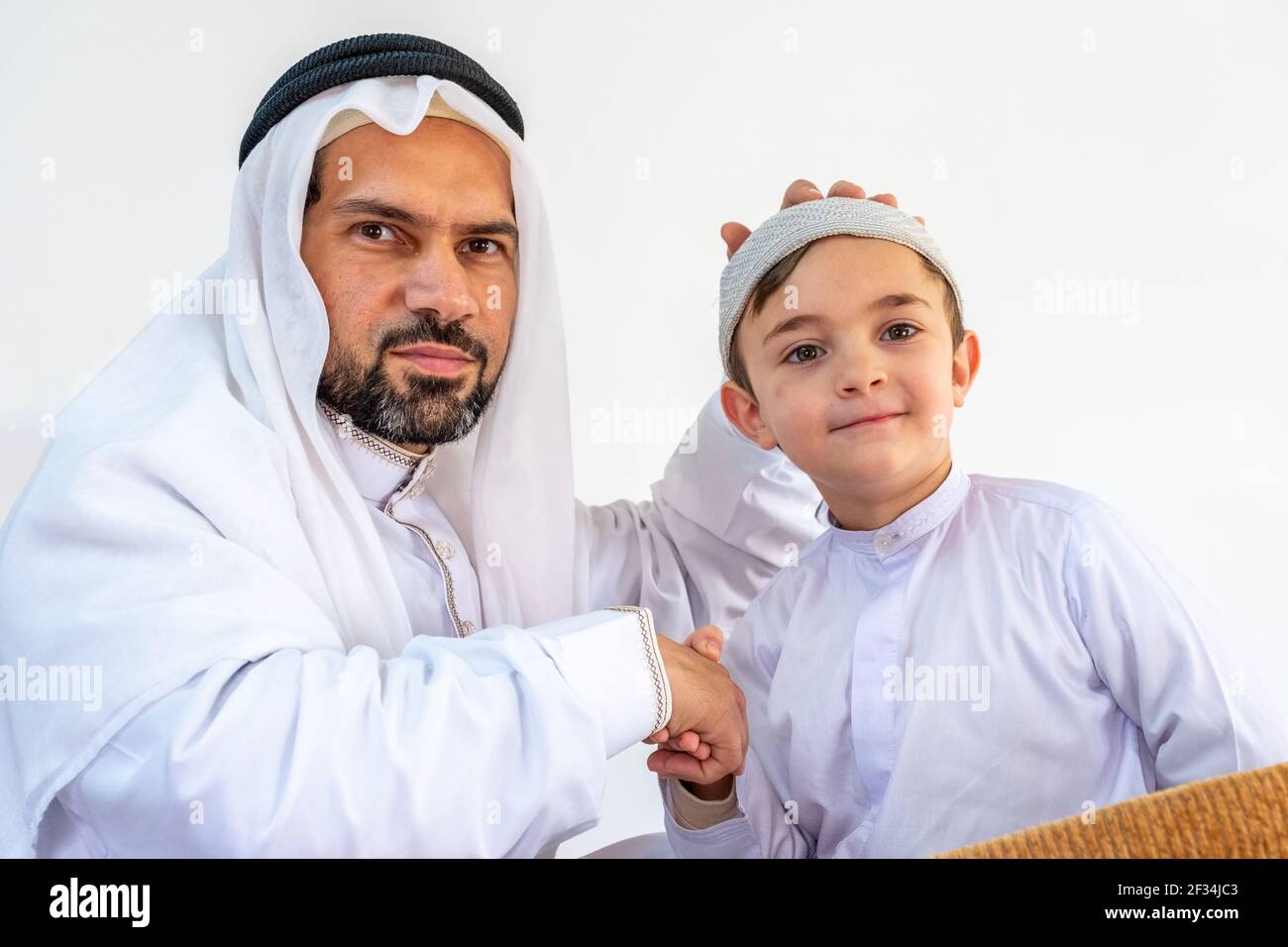 Arabic Muslim father and son feeling happy together Stock Photo - Alamy
