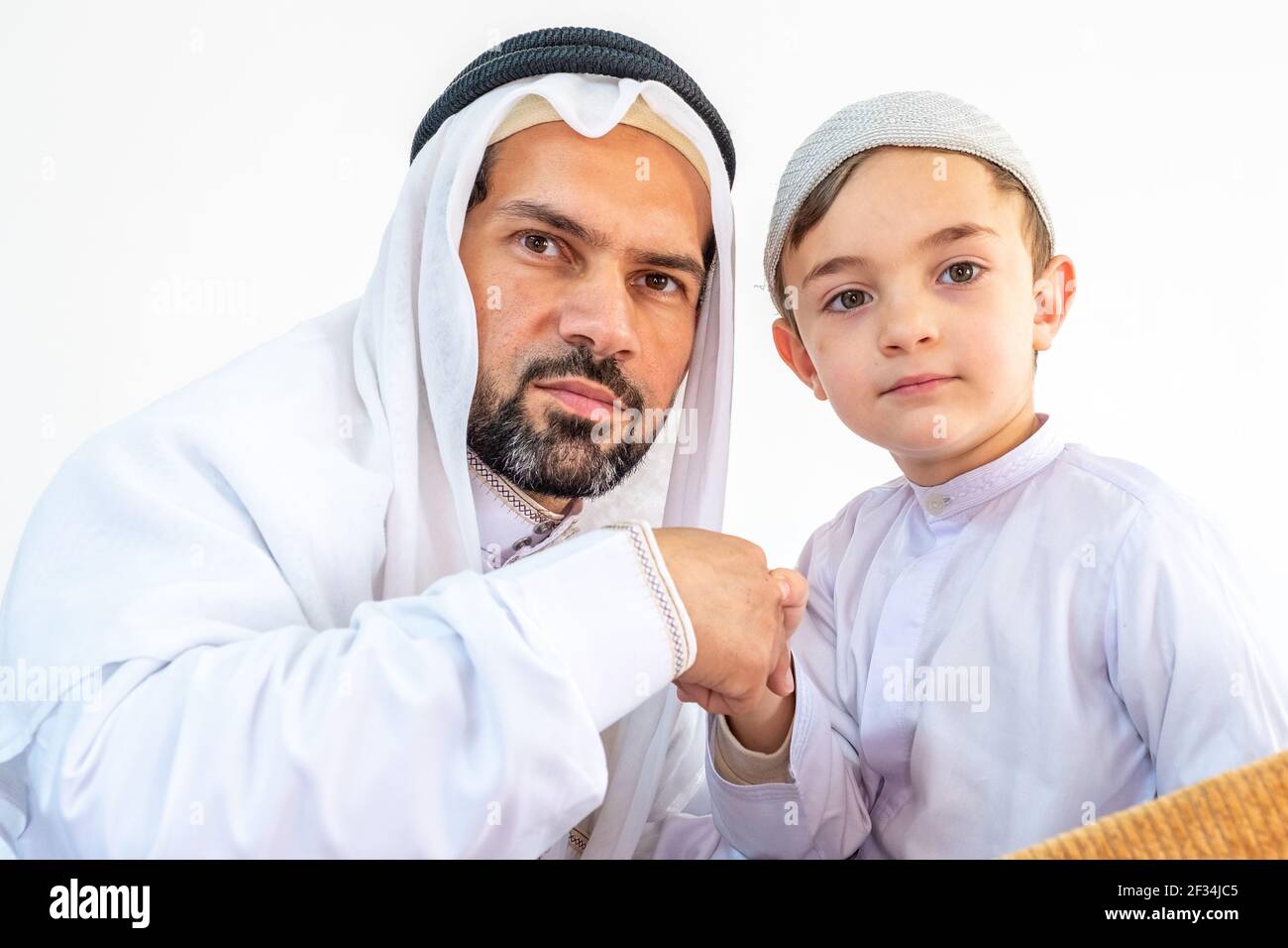 Arabic Muslim father and son feeling happy together Stock Photo - Alamy