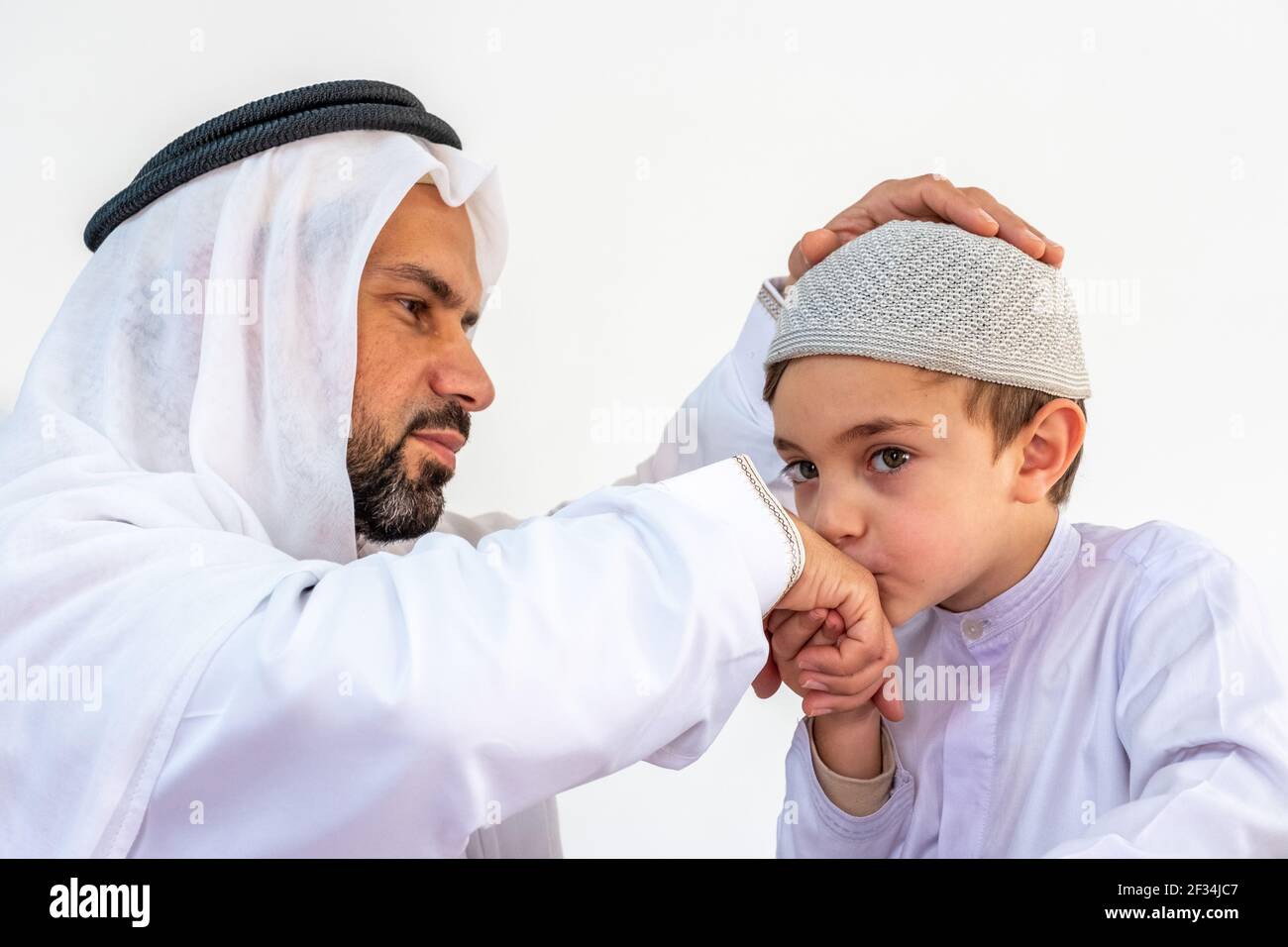Arabic muslim son kissing his father hand Stock Photo - Alamy