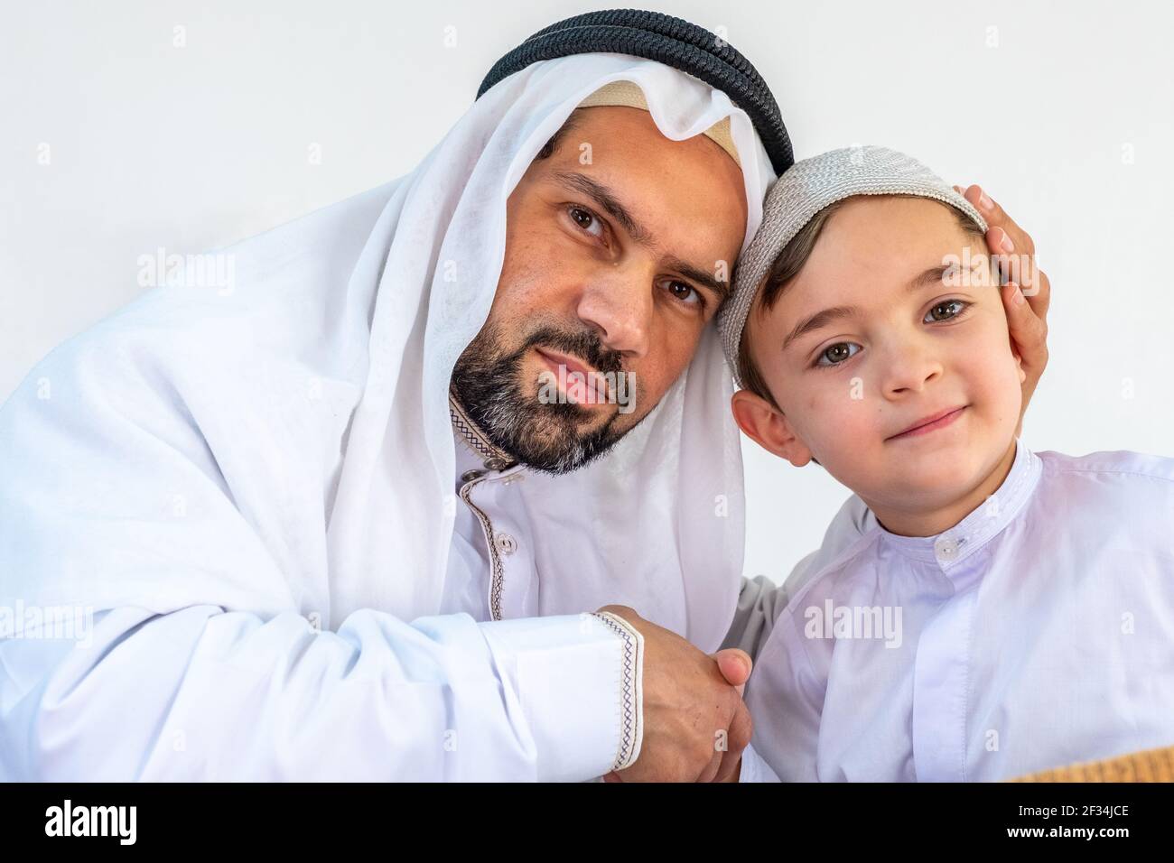 Arabic Muslim father and son feeling happy together Stock Photo - Alamy