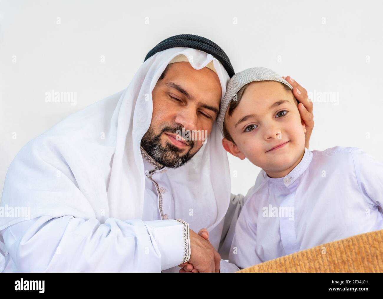 Arabic Muslim father and son feeling happy together Stock Photo - Alamy