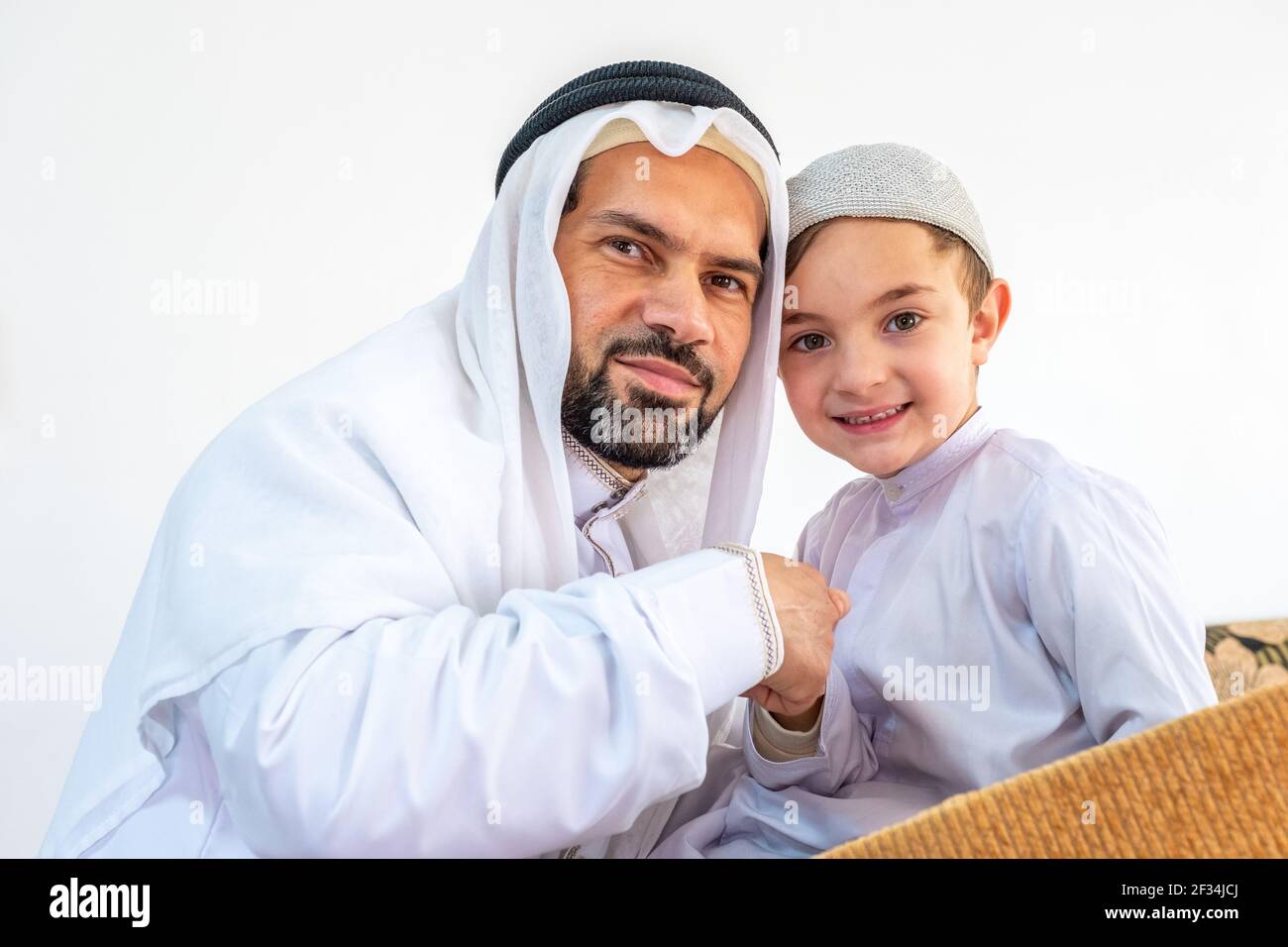 Arabic Muslim father and son feeling happy together Stock Photo - Alamy