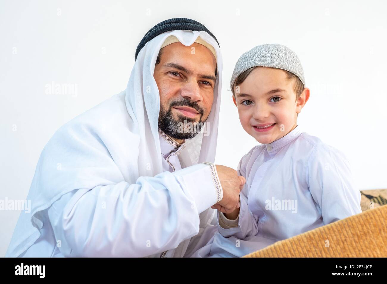 Arabic Muslim father and son feeling happy together Stock Photo - Alamy
