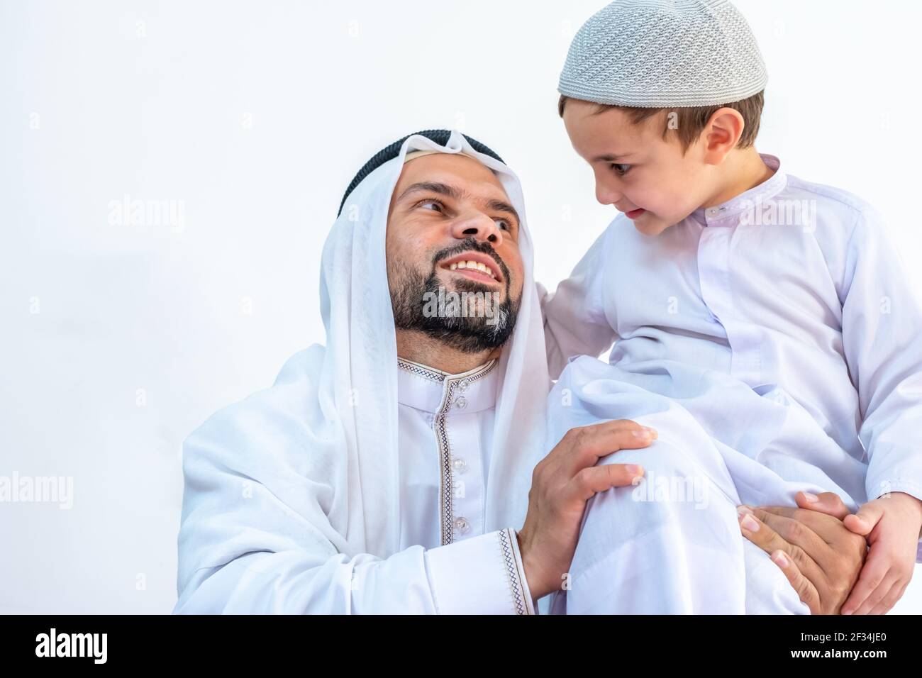 Arabic muslim father holding his son on his shoulder Stock Photo - Alamy