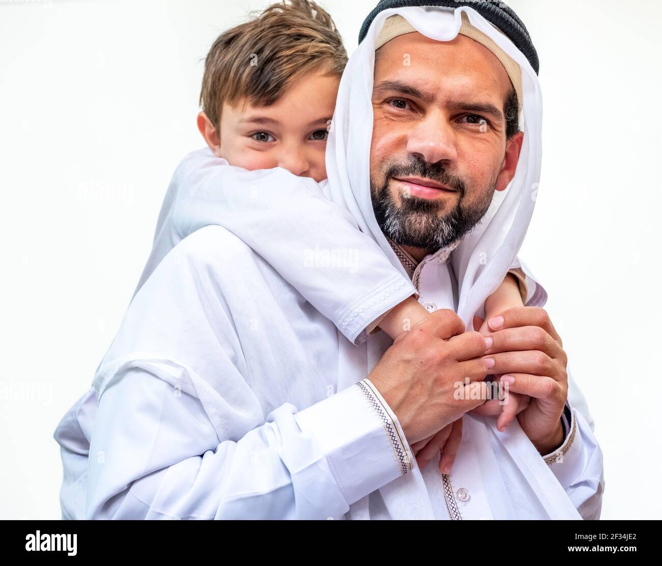 Happy Arabic Muslim father and his on his back Stock Photo - Alamy