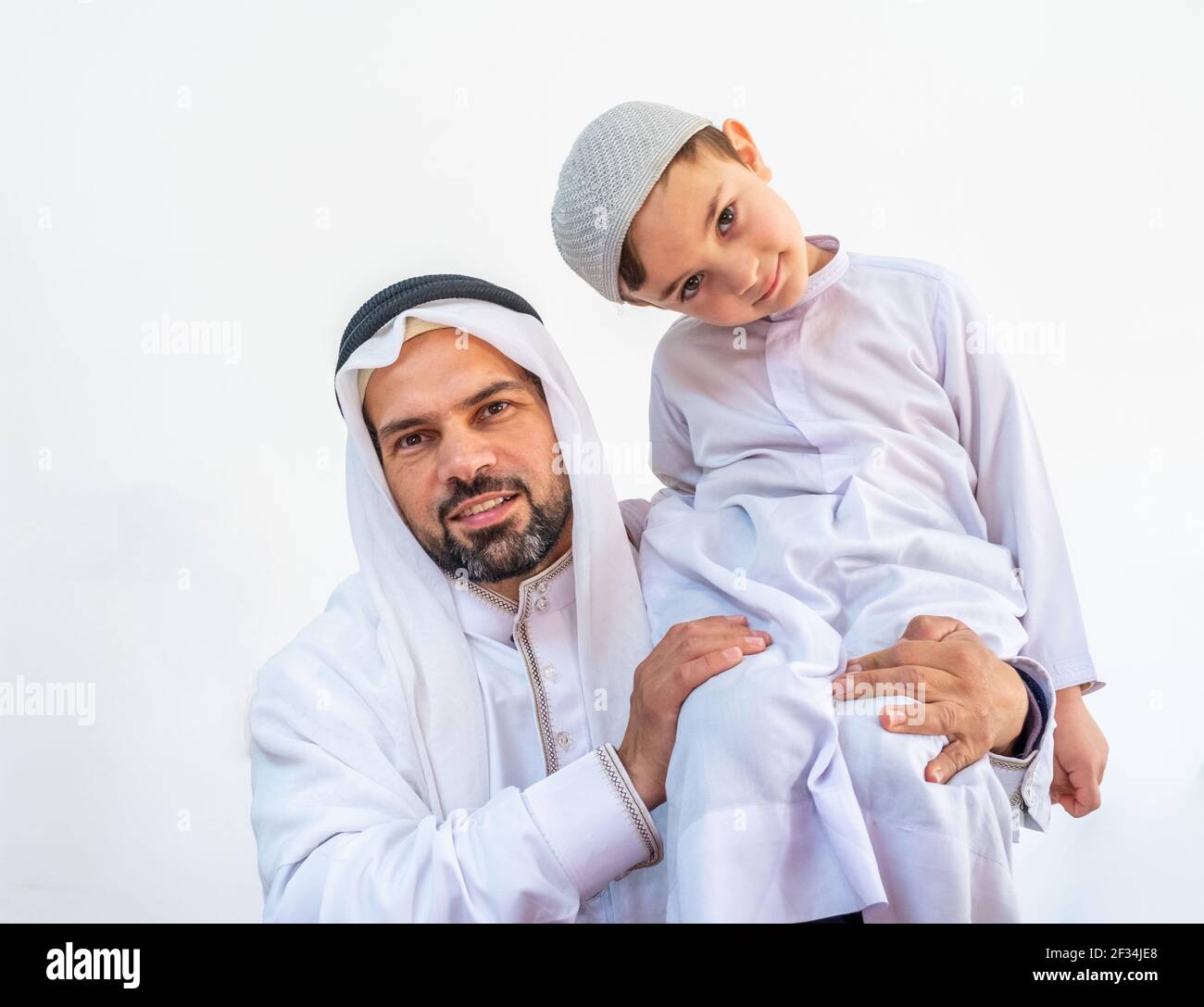 Arabic muslim father holding his son on his shoulder Stock Photo - Alamy