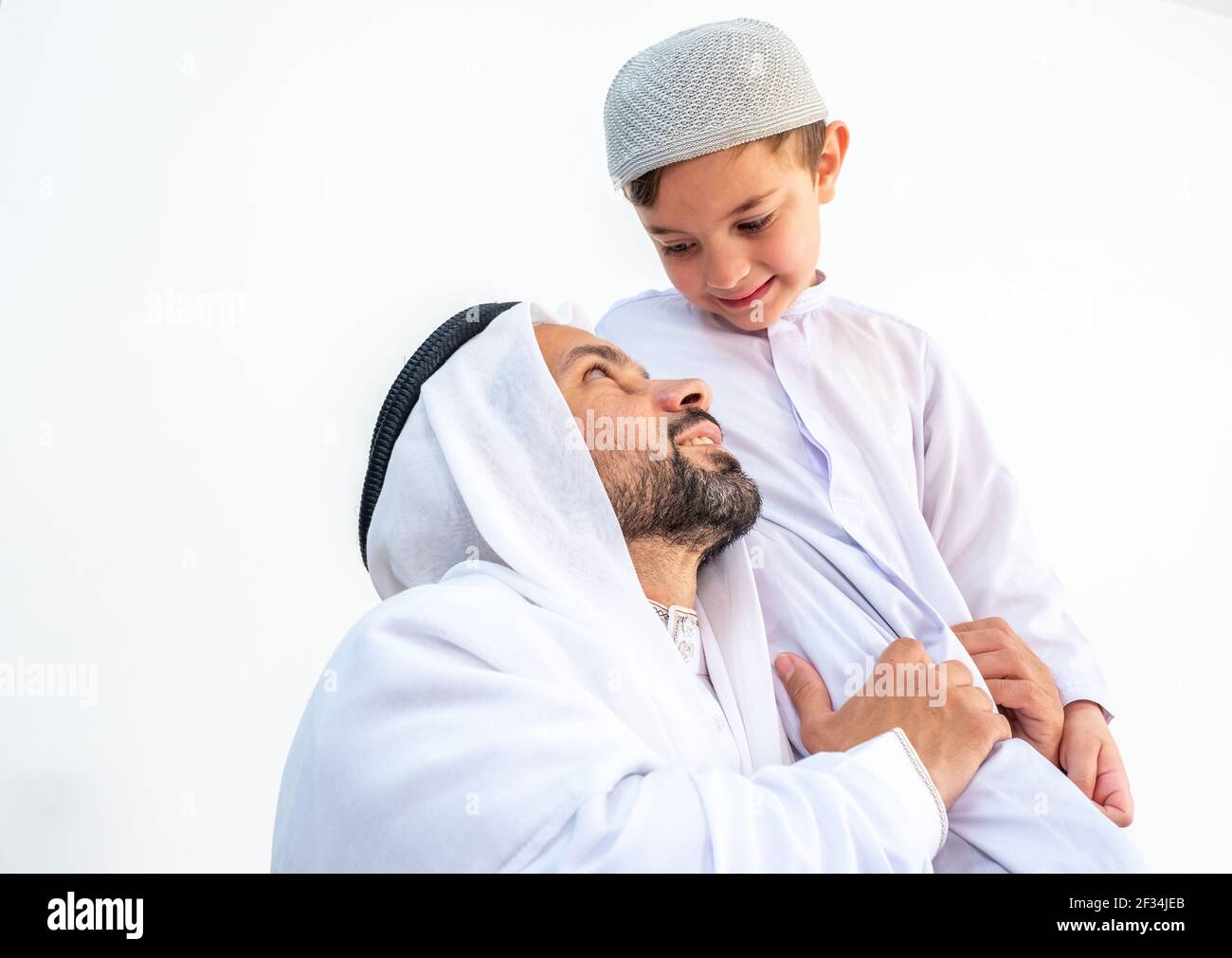 Arabic muslim father holding his son on his shoulder Stock Photo - Alamy