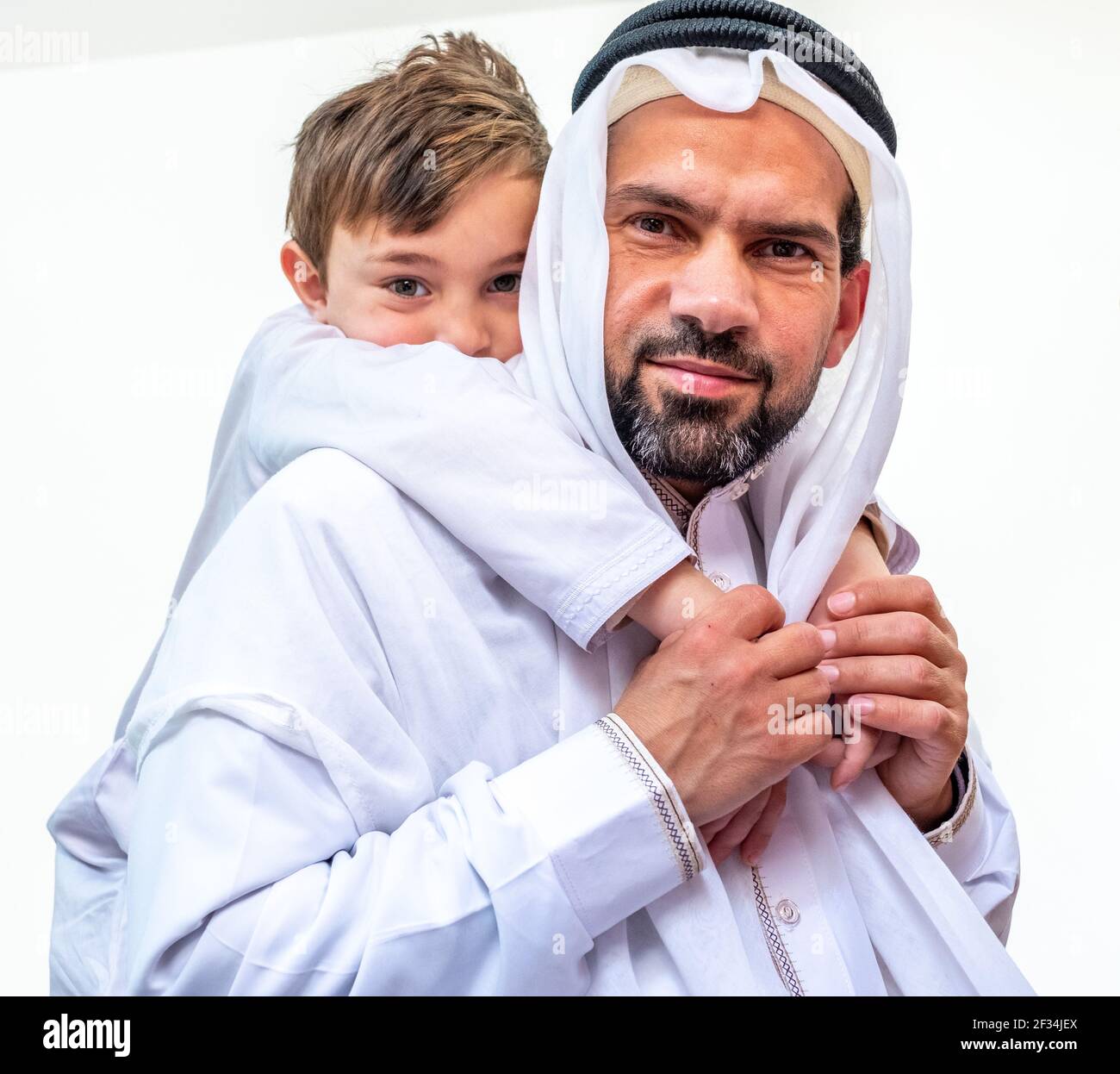 Happy Arabic Muslim father and his on his back Stock Photo - Alamy