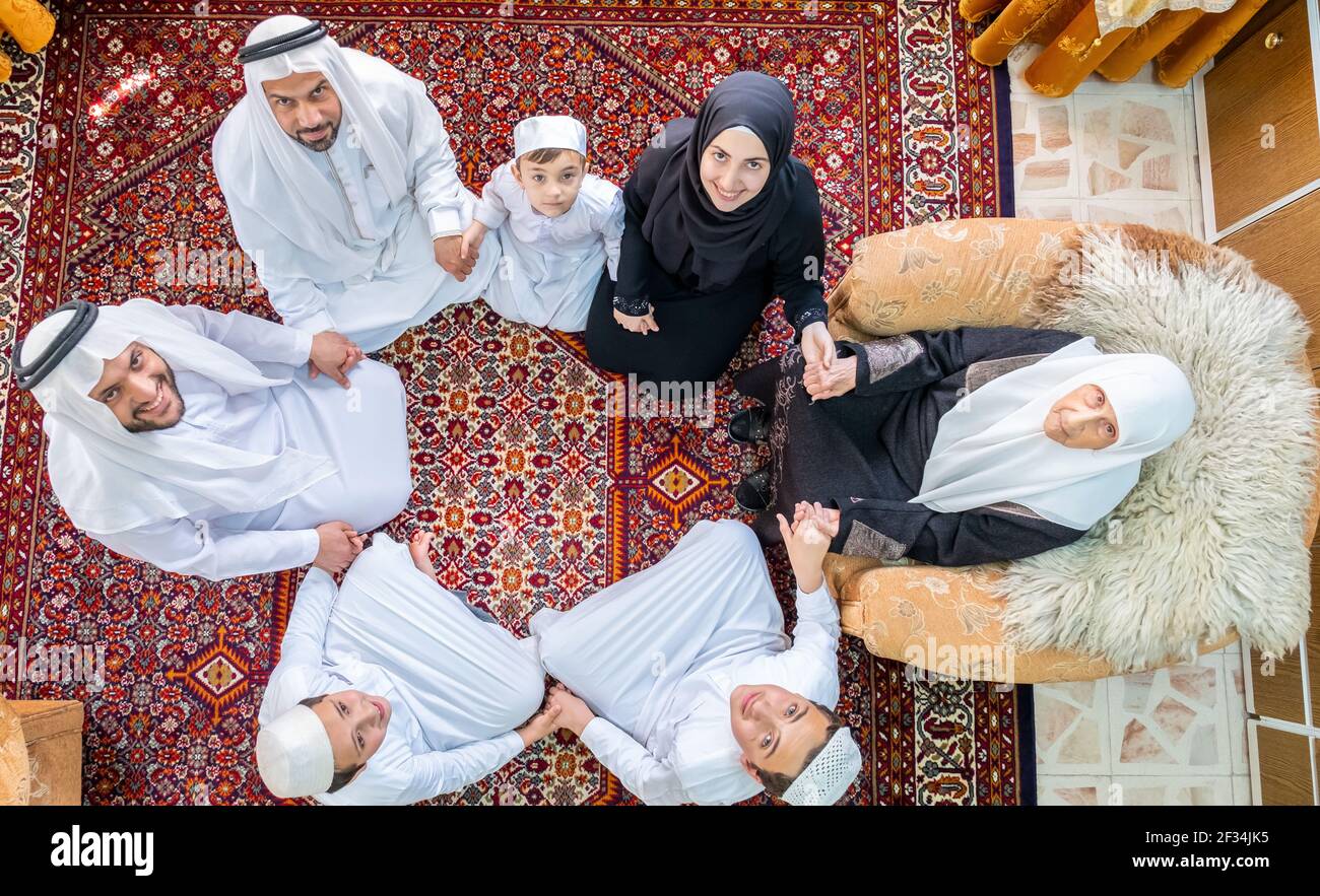 happy Muslim family holding hands together Stock Photo - Alamy