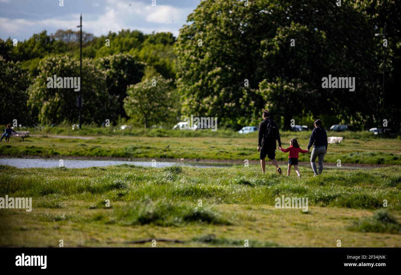 A family taking a walk on Wimbledon and Putney Commons during the Covid ...