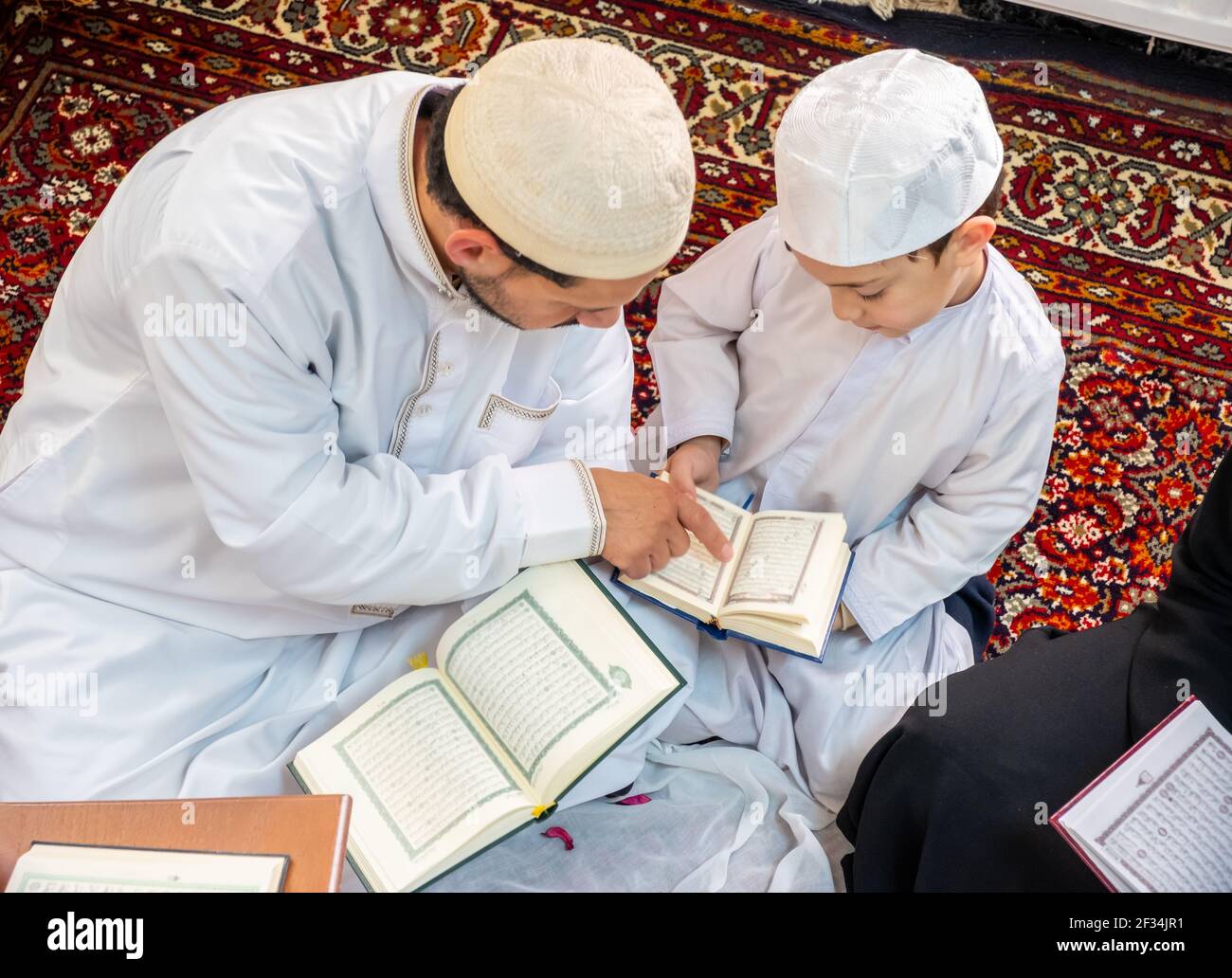 Happy arabic family reading and learning quraan during ramadan Stock ...