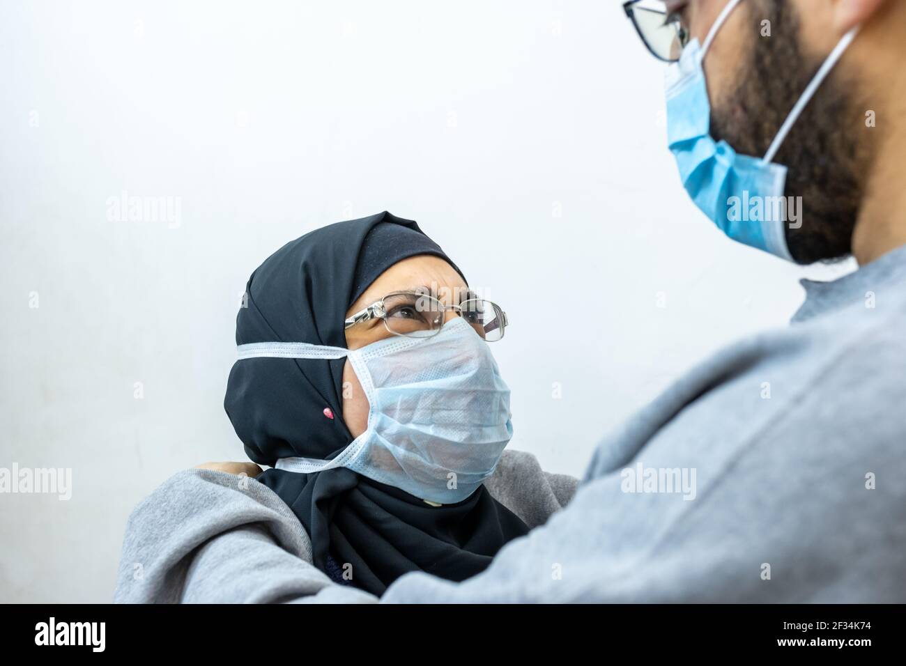 Arabic Muslim male and female wearing masks Stock Photo - Alamy