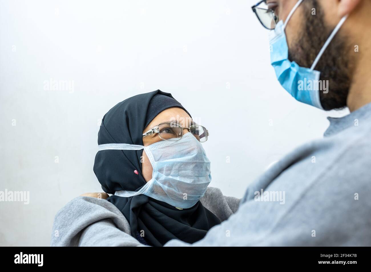 Arabic Muslim male and female wearing masks Stock Photo - Alamy
