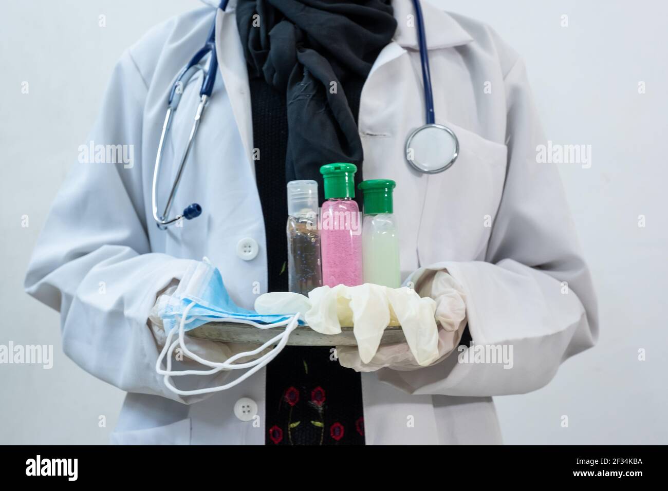 Arabic Muslim doctor wearing a mask and presenting hygiene and ...