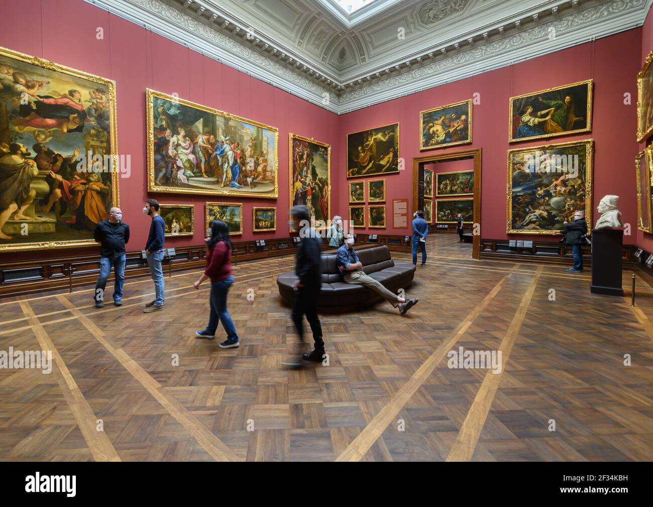 Dresden, Germany. 15th Mar, 2021. Visitors look at paintings in the Old ...