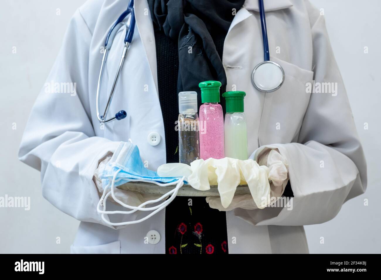 Arabic Muslim doctor wearing a mask and presenting hygiene and ...
