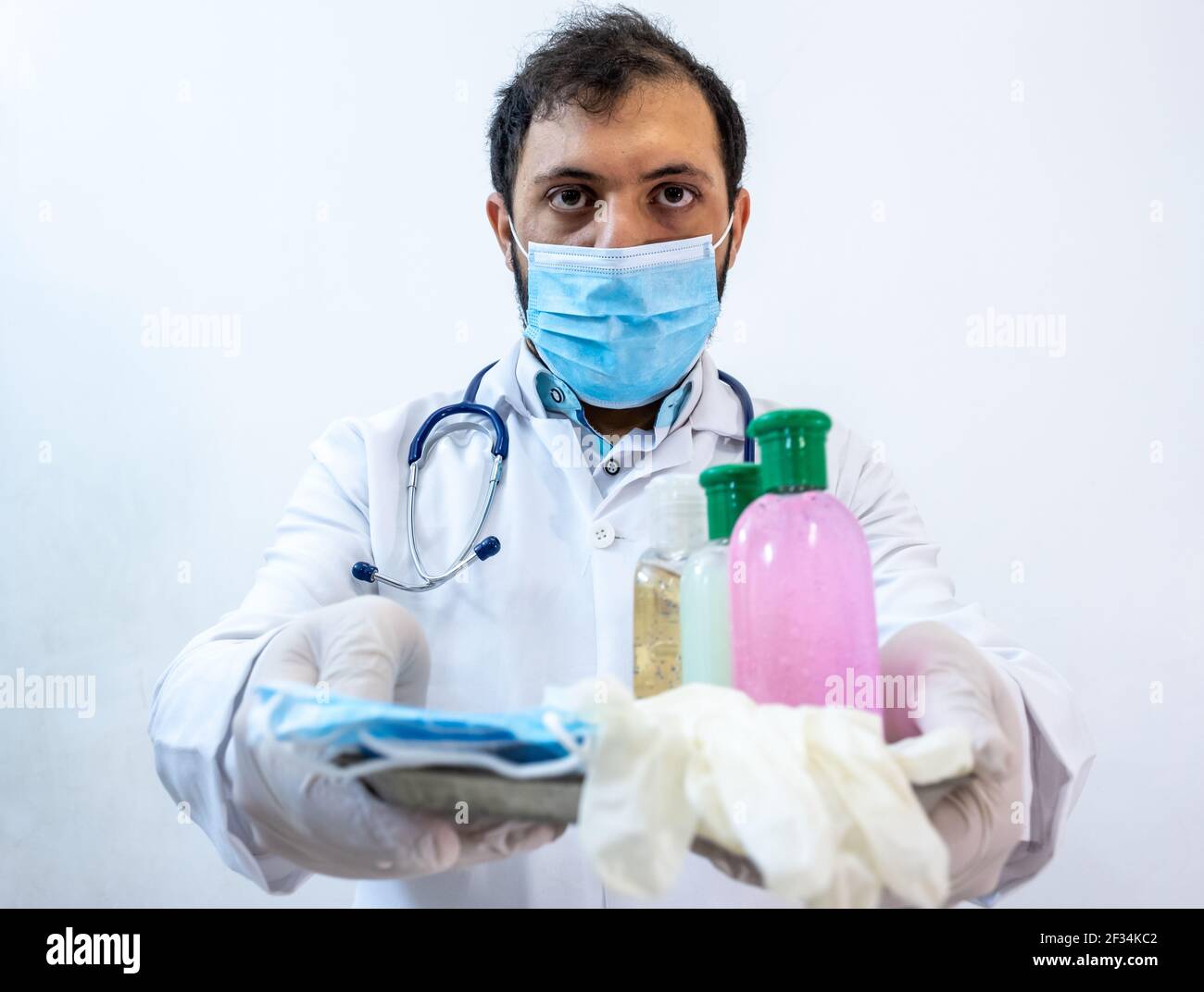 Arabic Muslim doctor wearing a mask and presenting hygiene and ...