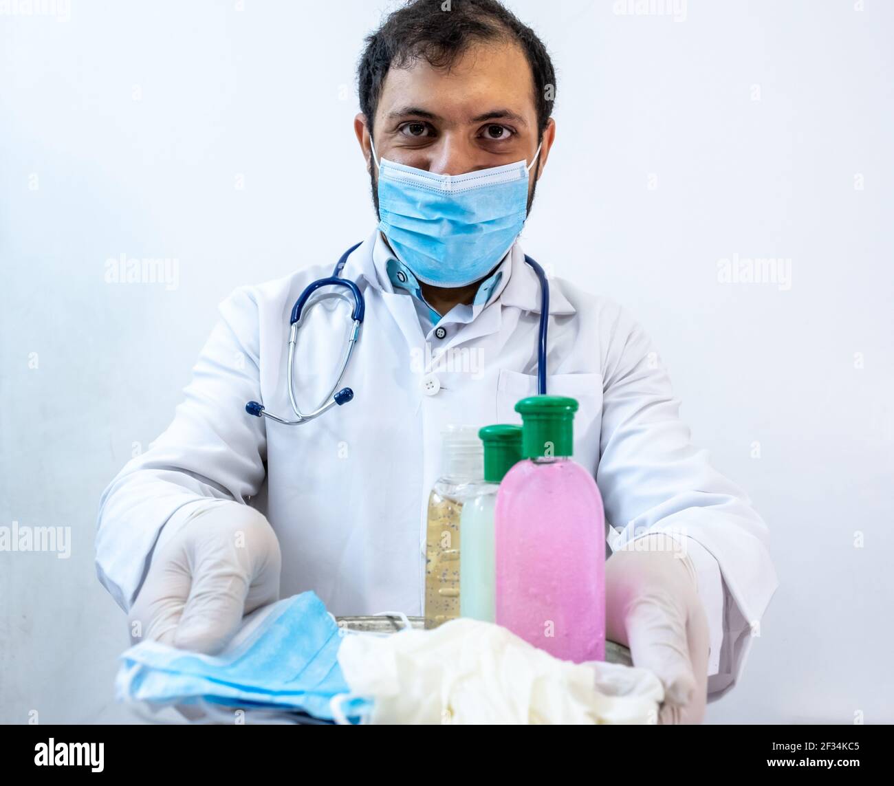 Arabic Muslim doctor wearing a mask and presenting hygiene and ...