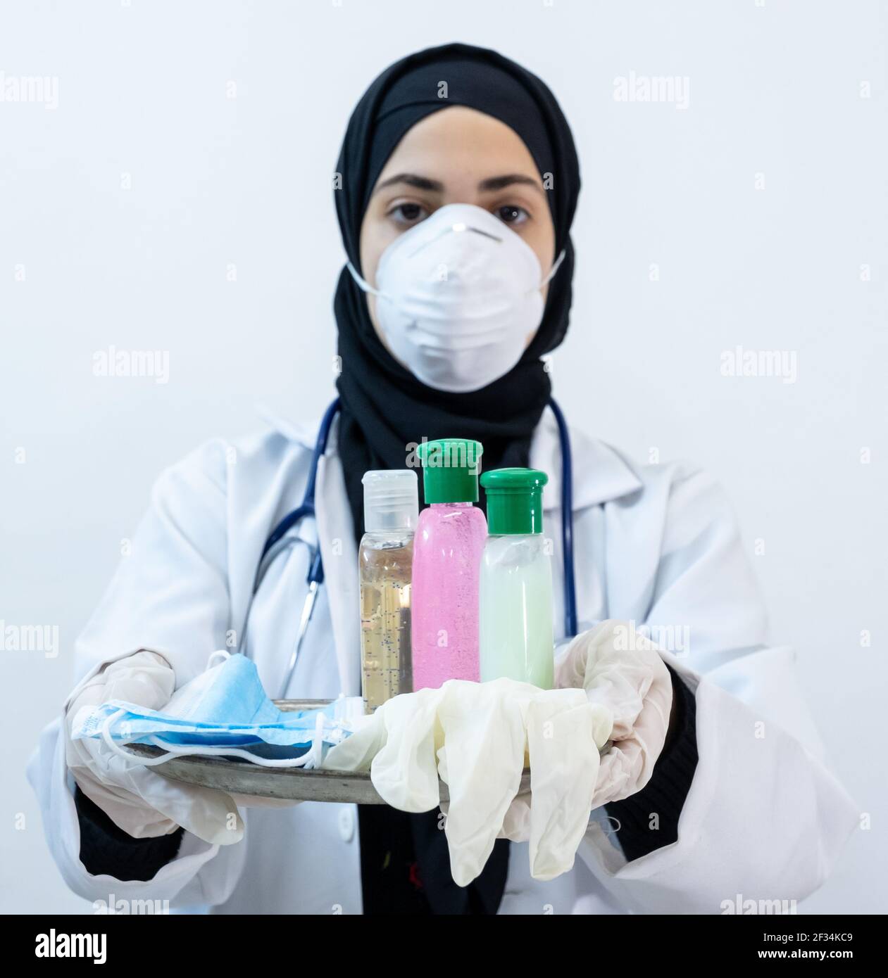 Arabic Muslim doctor wearing a mask and presenting hygiene and ...
