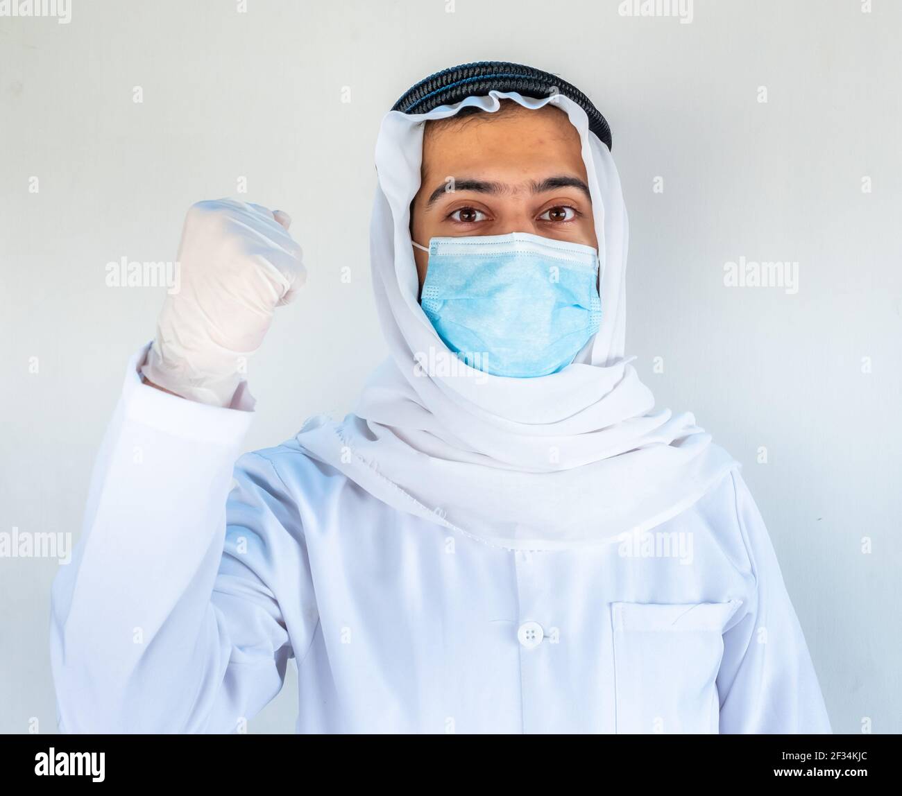 Arabic Muslim doctor wearing a mask with hygiene products Stock Photo ...