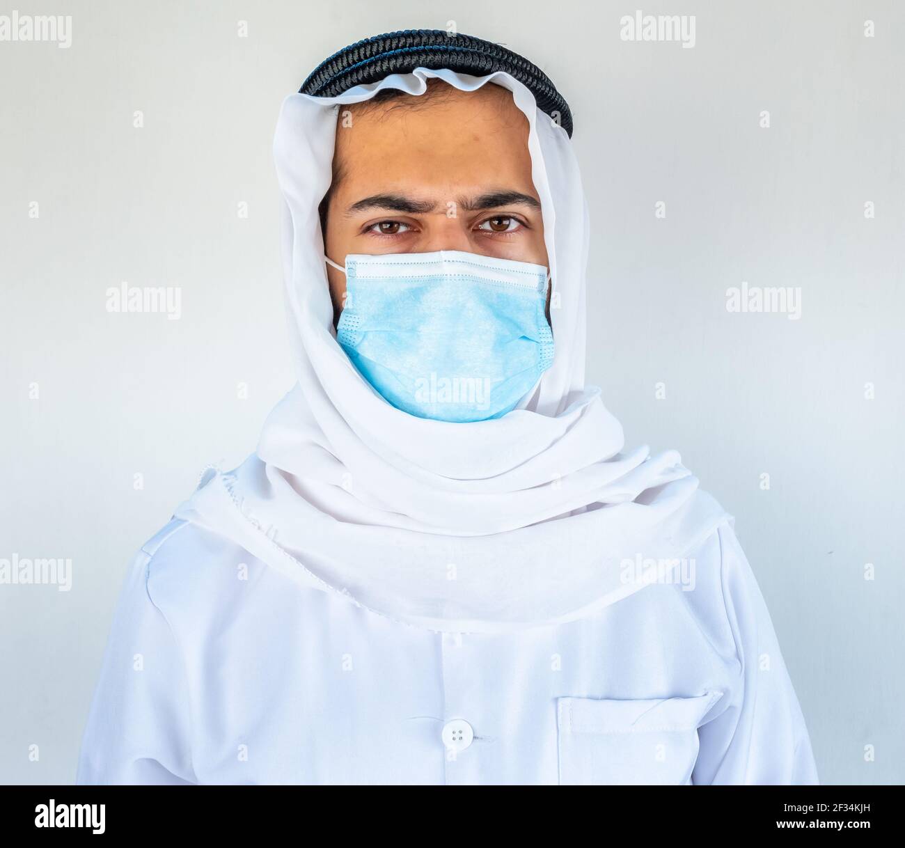 Arabic Muslim doctor wearing a mask with hygiene products Stock Photo ...