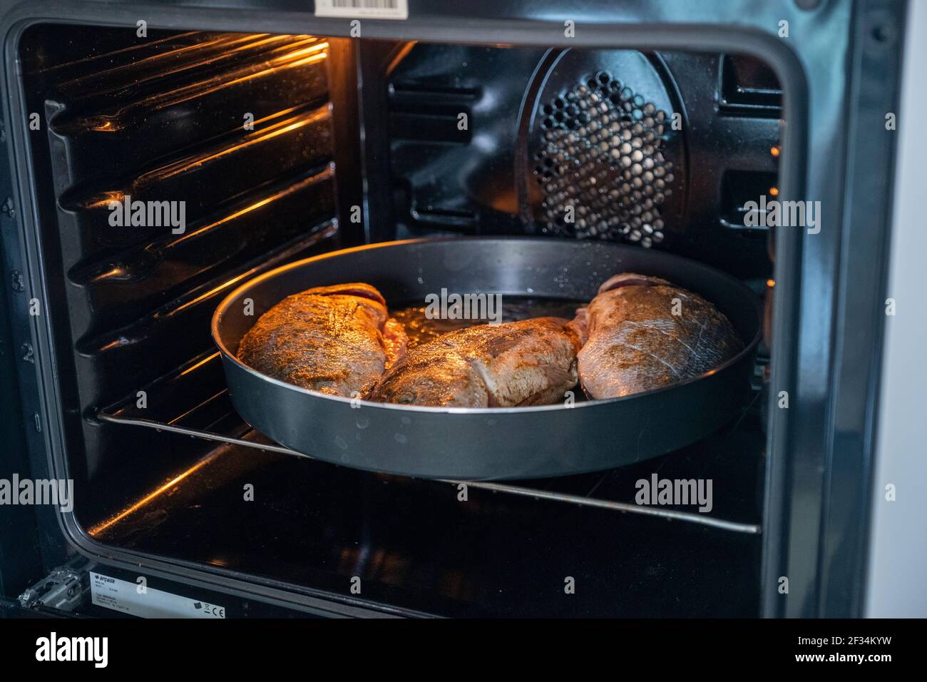 Tray of fishes is going into the oven to be cooked Stock Photo - Alamy
