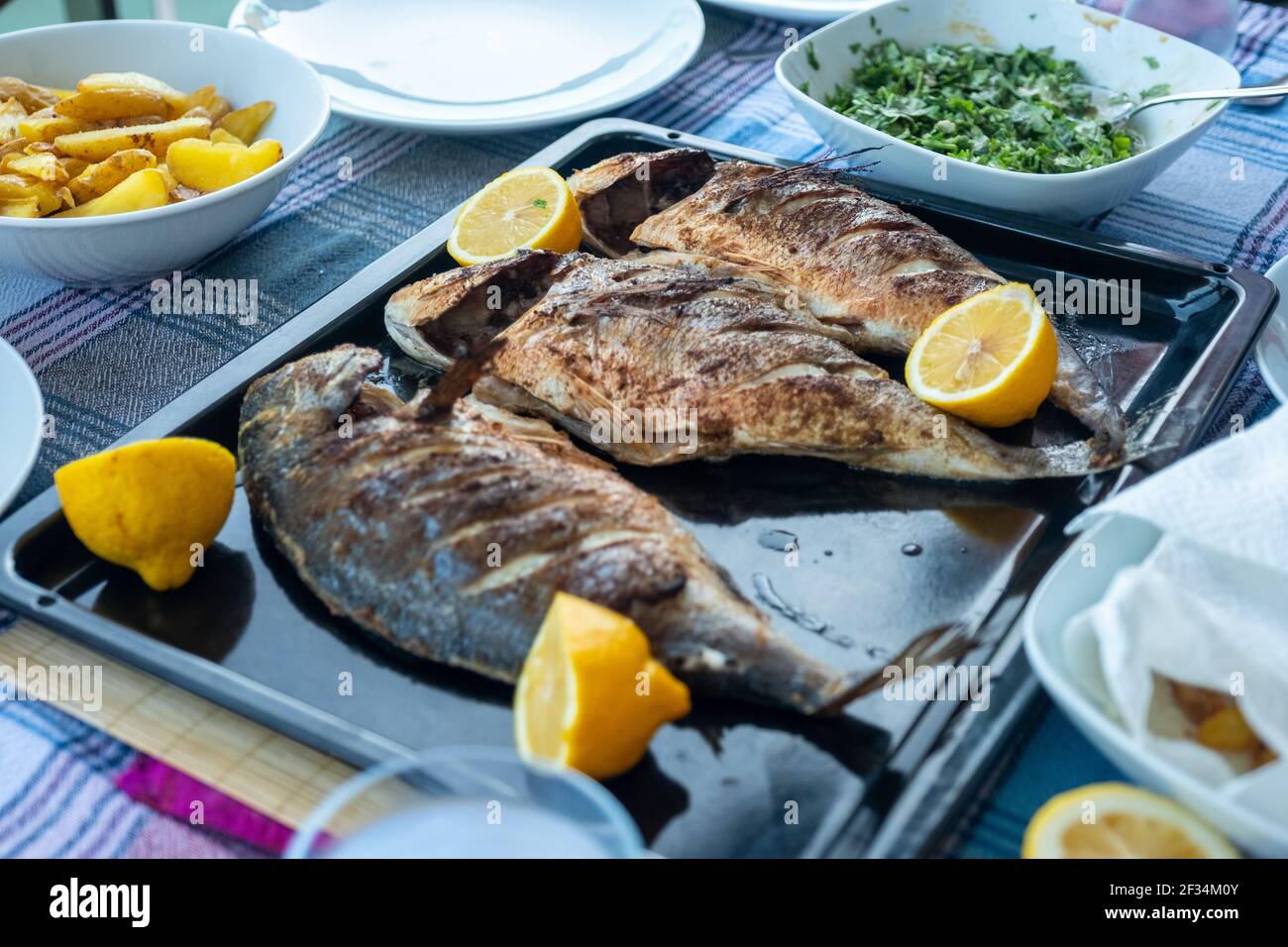 Family gathering to eat fish together Stock Photo - Alamy