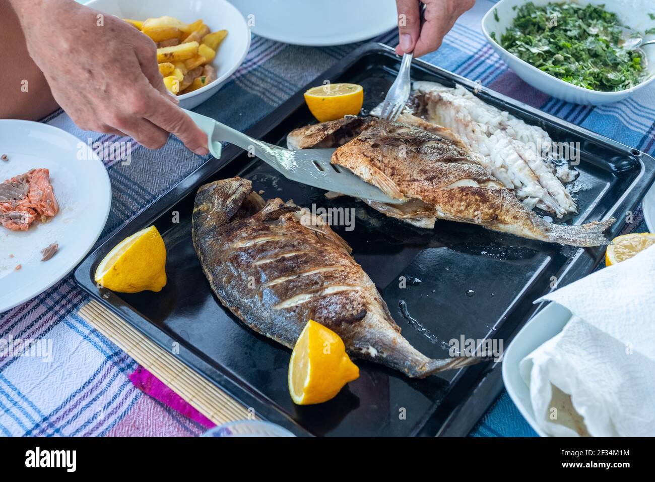 Family gathering to eat fish together Stock Photo - Alamy