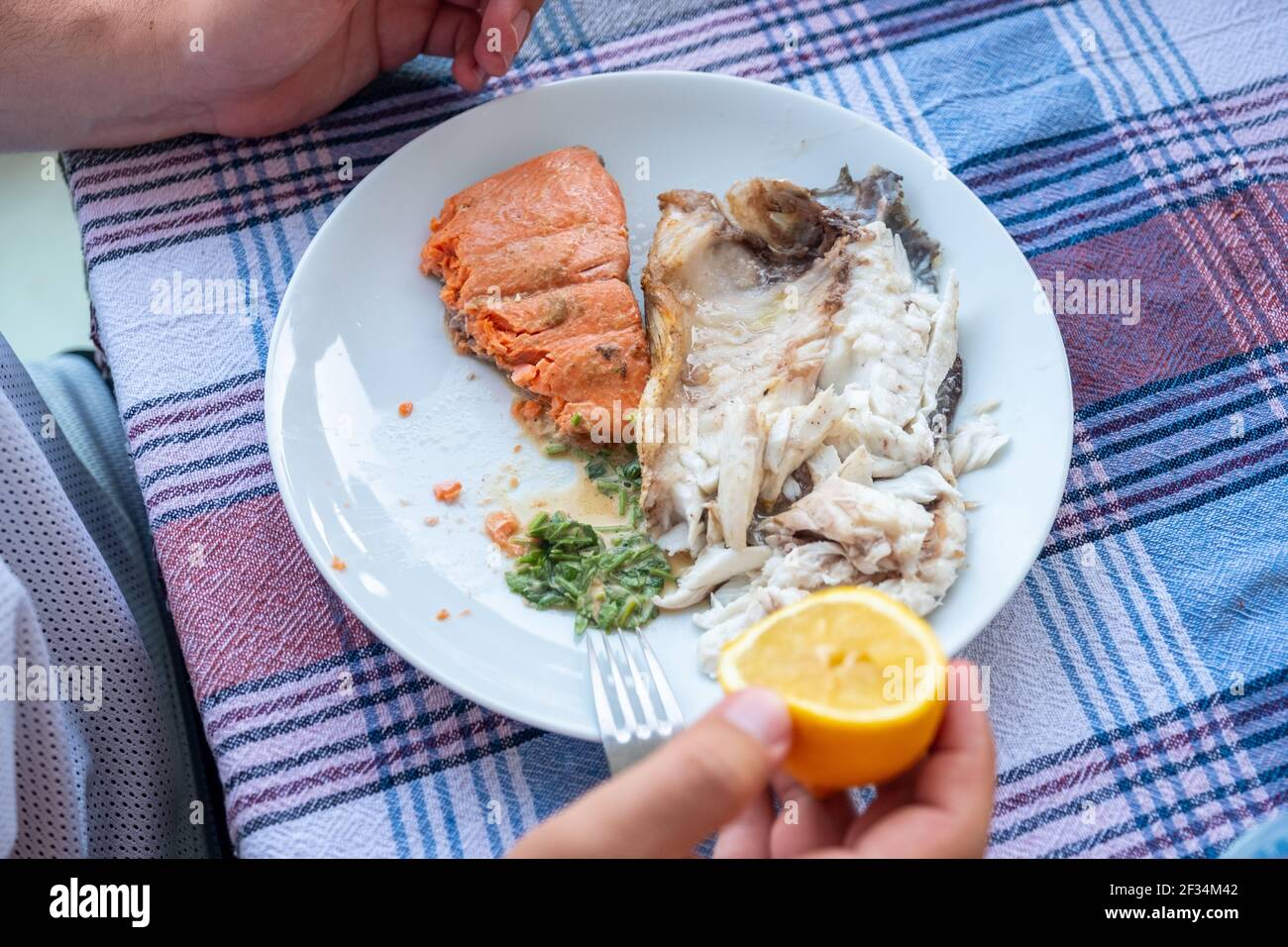 Family gathering to eat fish together Stock Photo - Alamy