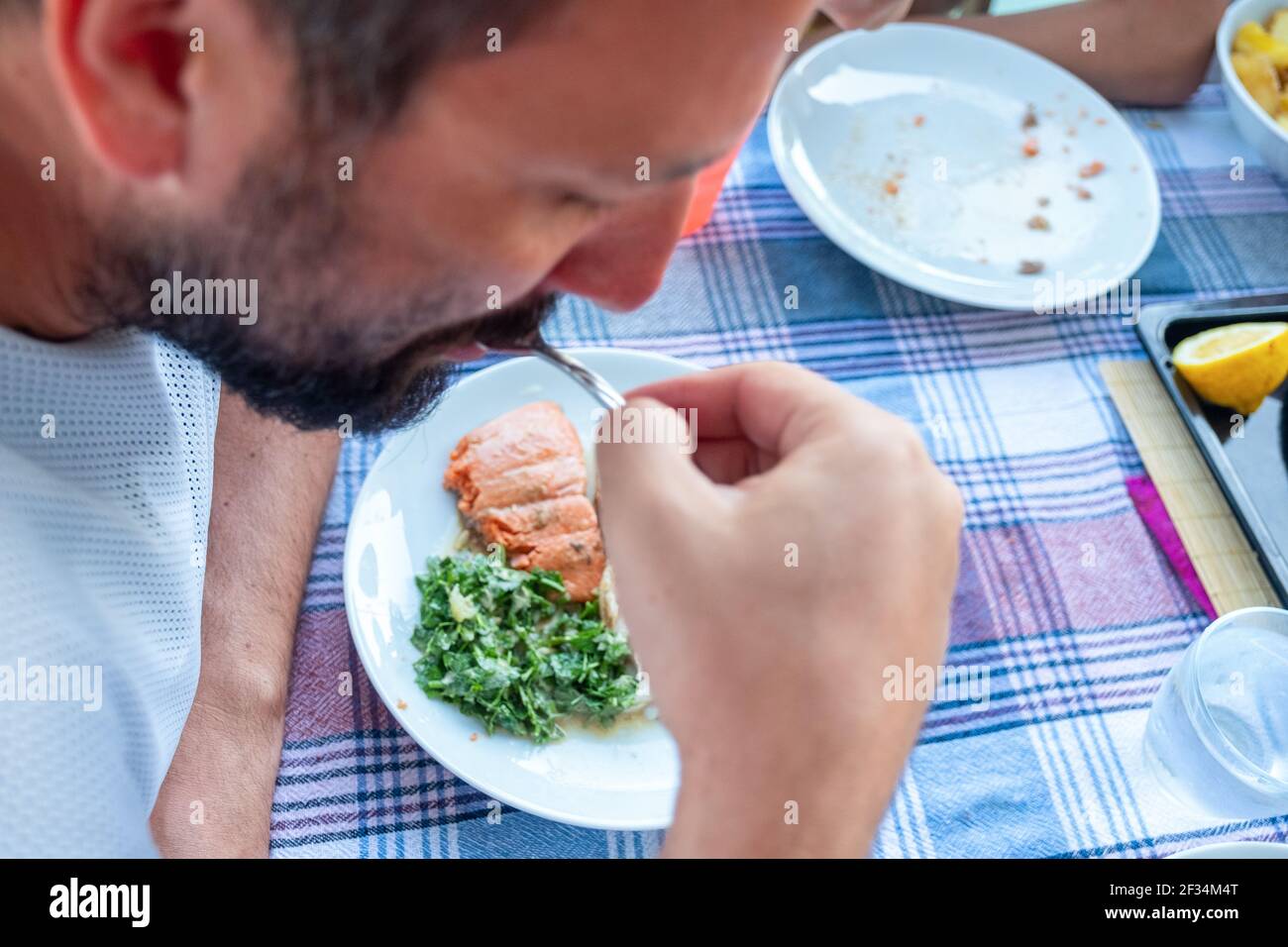 Family gathering to eat fish together Stock Photo - Alamy