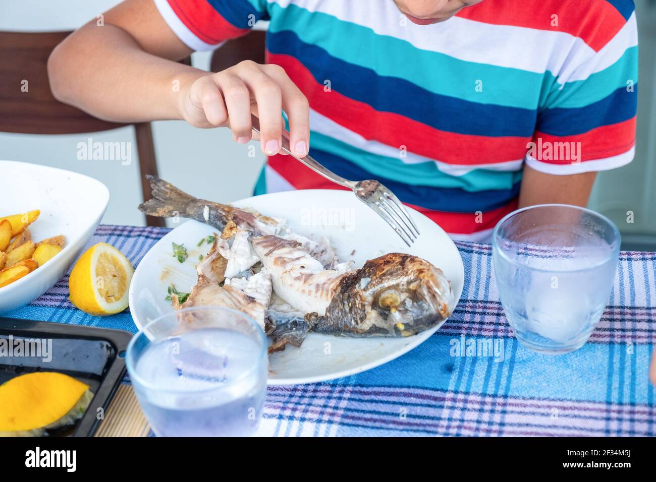 Family gathering to eat fish together Stock Photo - Alamy